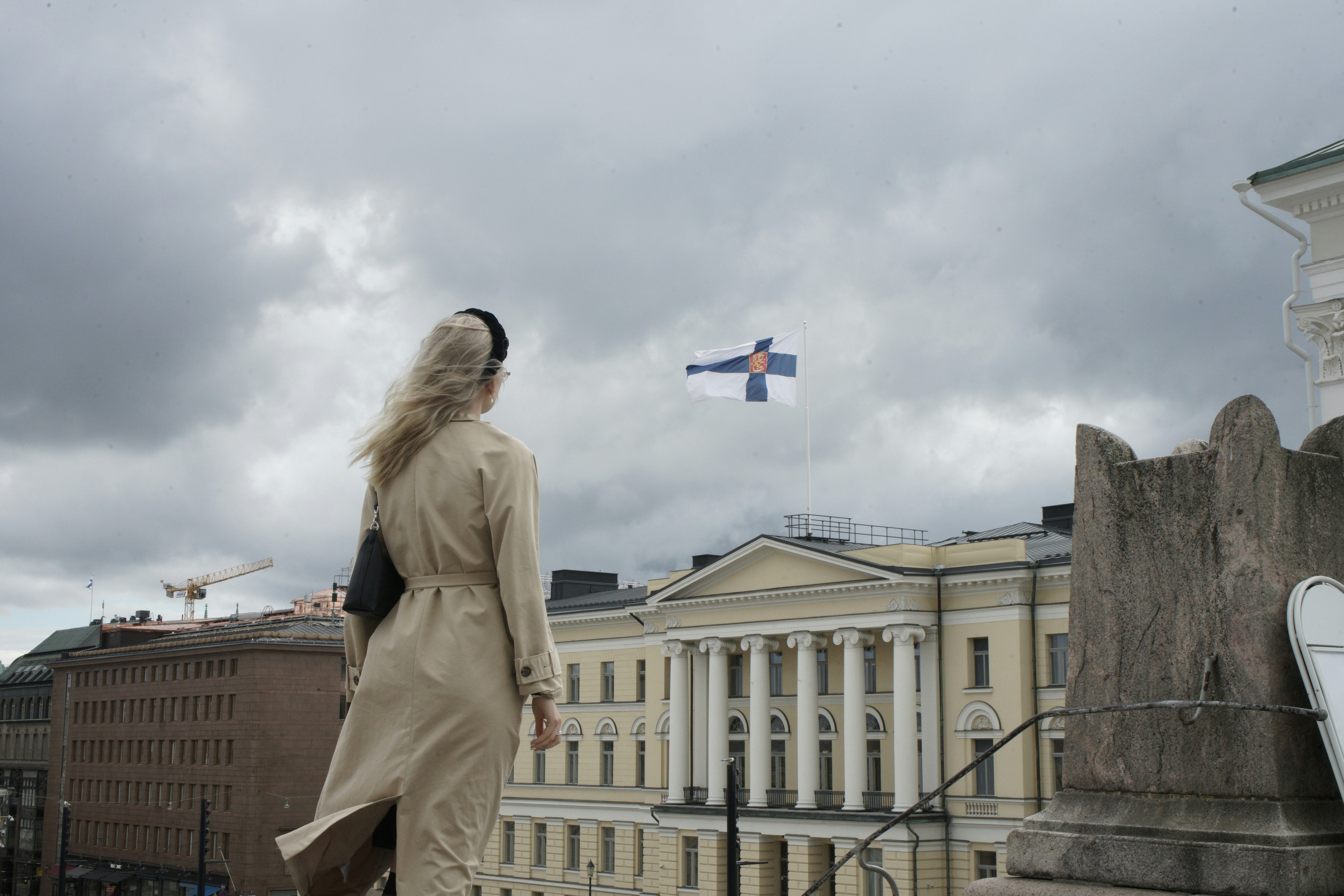 Trenchcoat Stroll Beneath a Sky of Grey