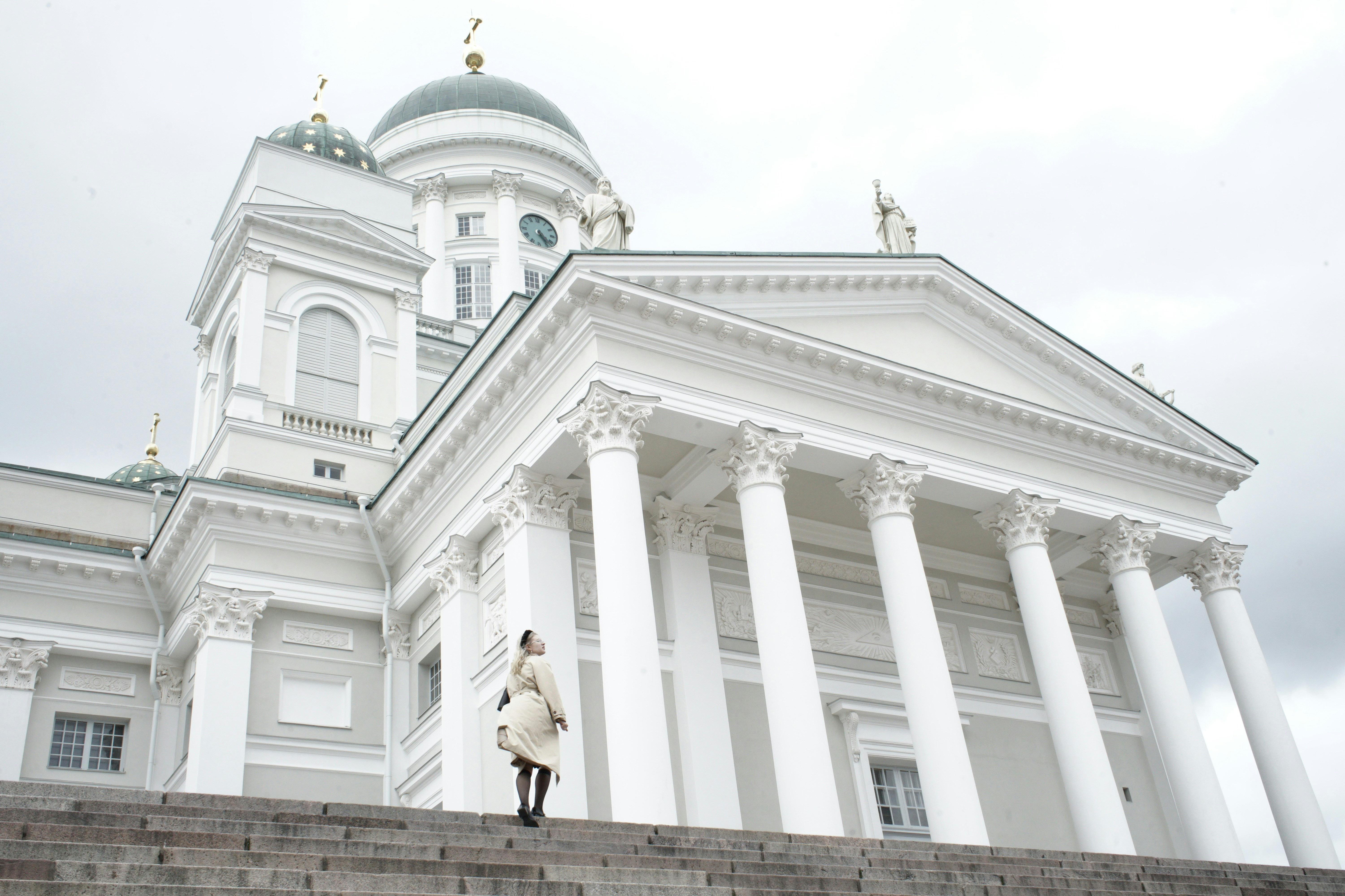 Steps Toward Grandeur: A solitary figure ascending a marble staircase before a neoclassical portico