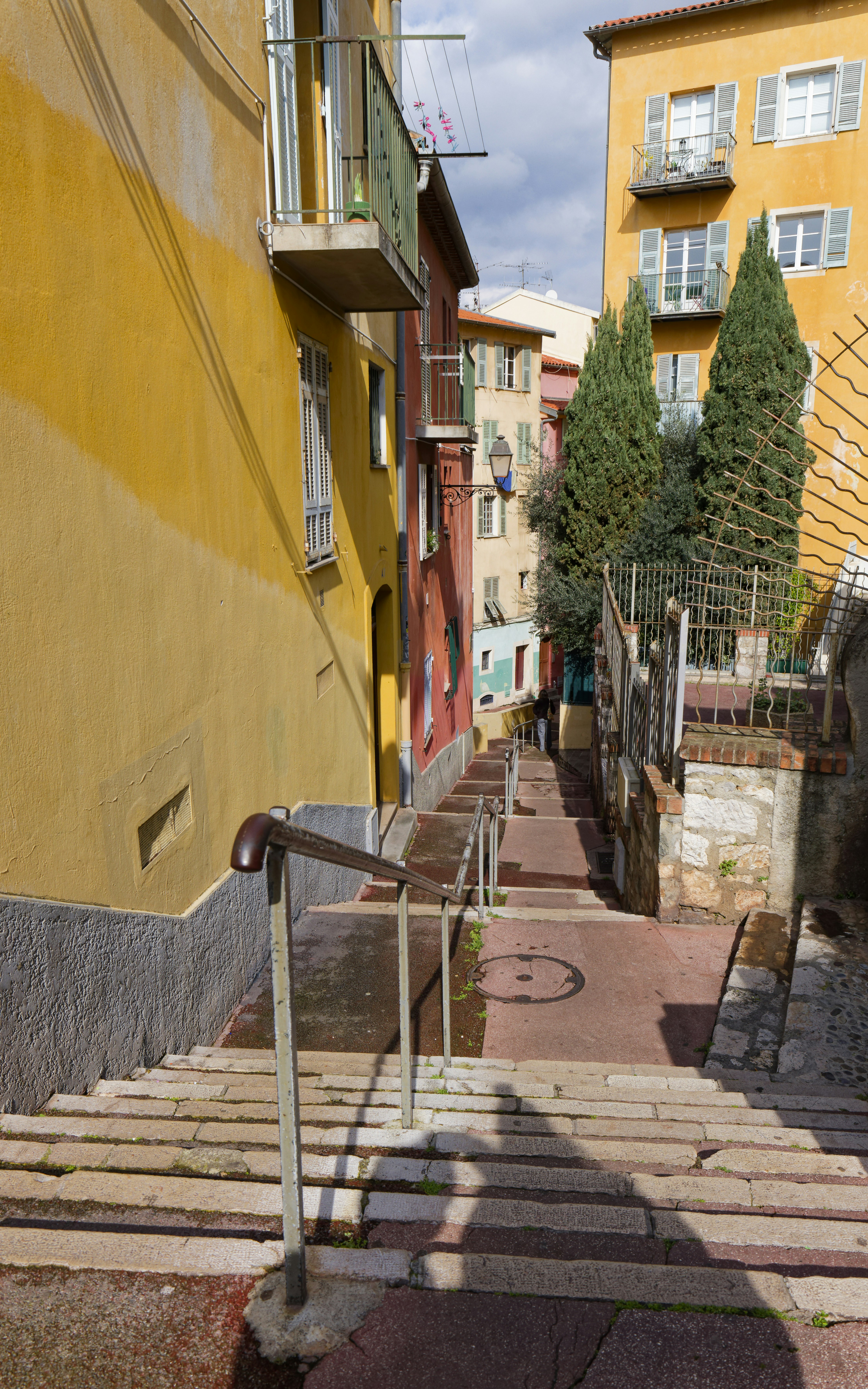 Sunlit Mediterranean Slope: Colorful Buildings and Winding Steps