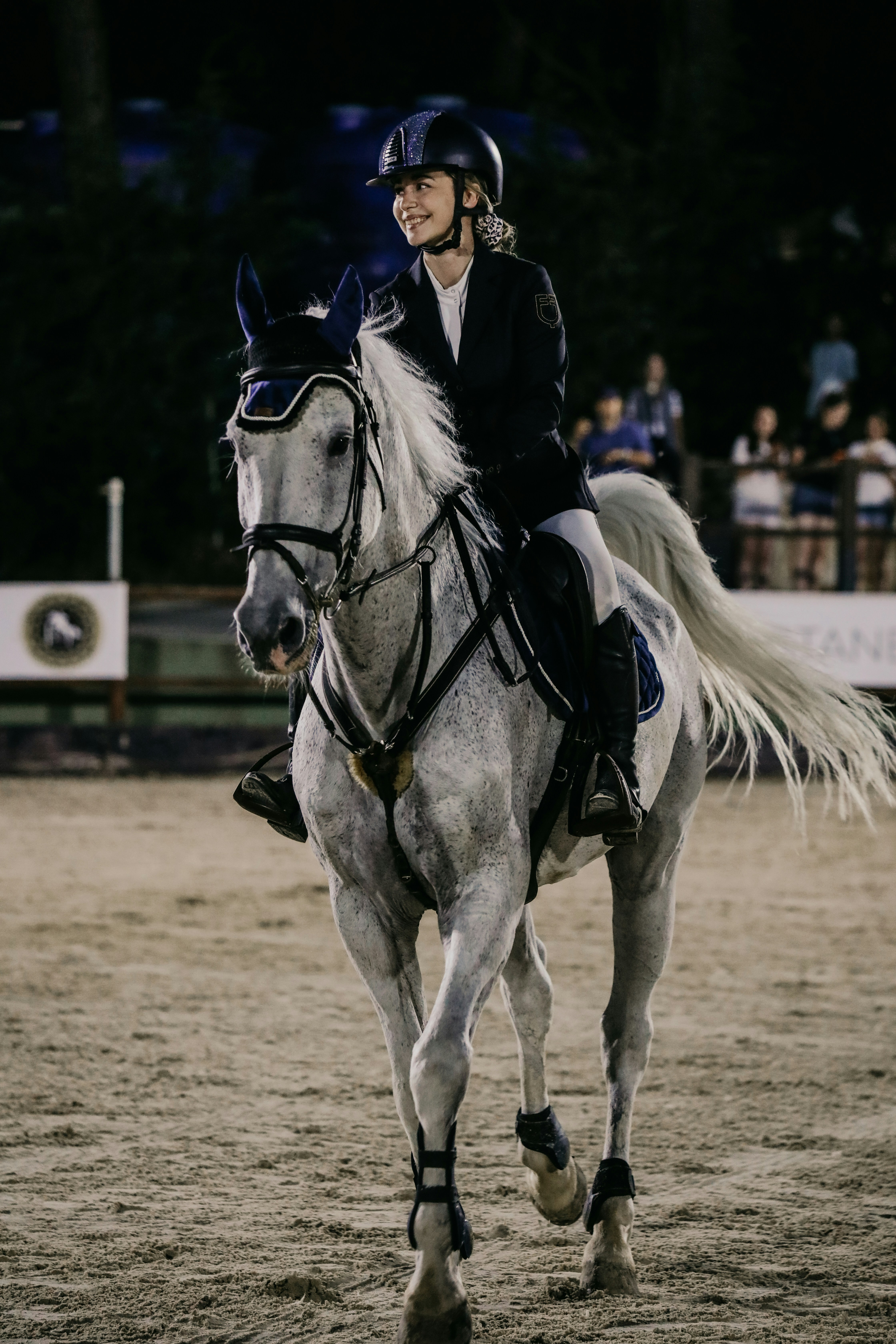 Rider in Night Arena: Confidence Afloat on a White Steed