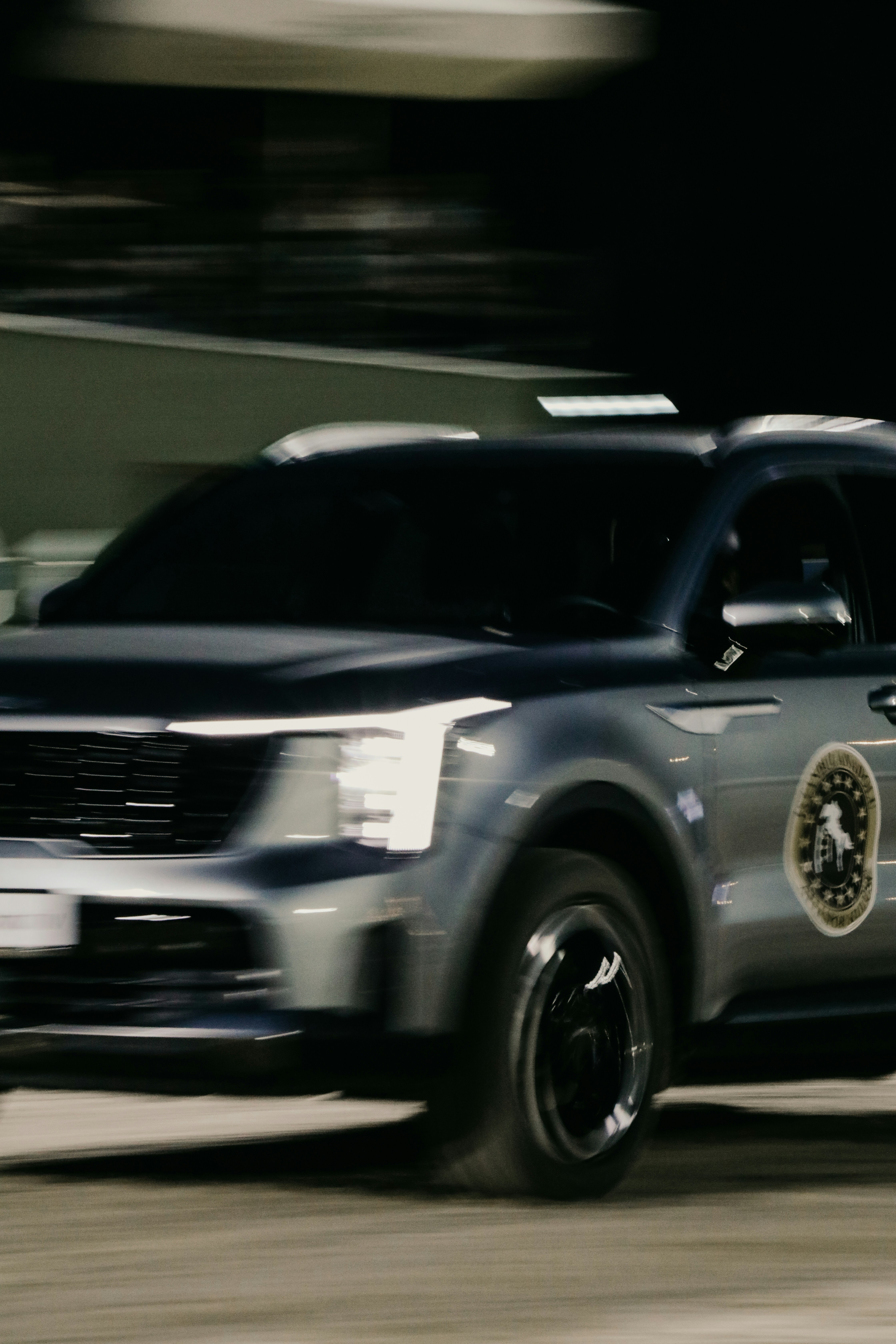 Motion in the Side Mirror: A Police SUV in Transit