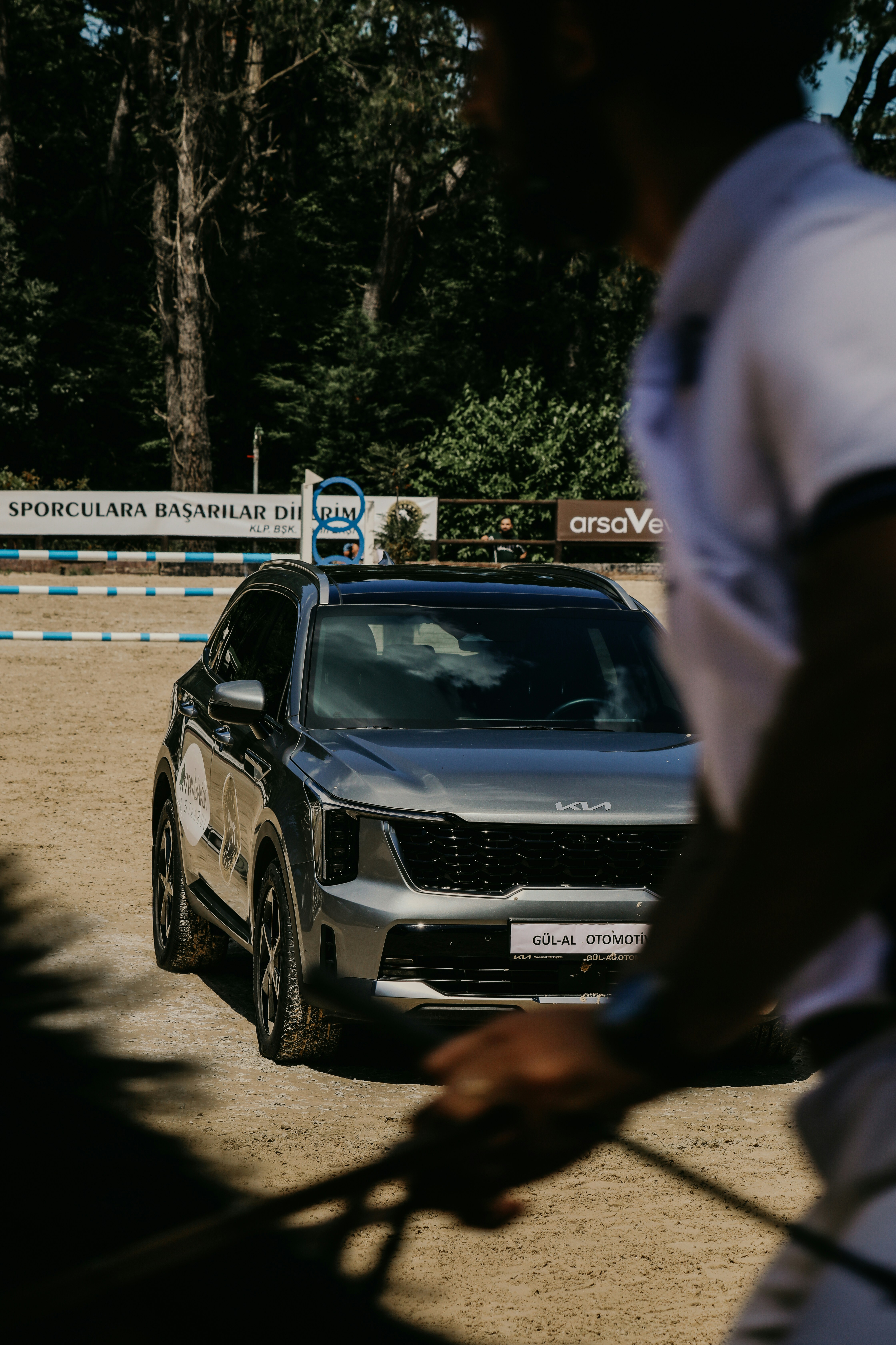 Silver SUV at an Arena: Spotlight on Motion and Edge of Shadow