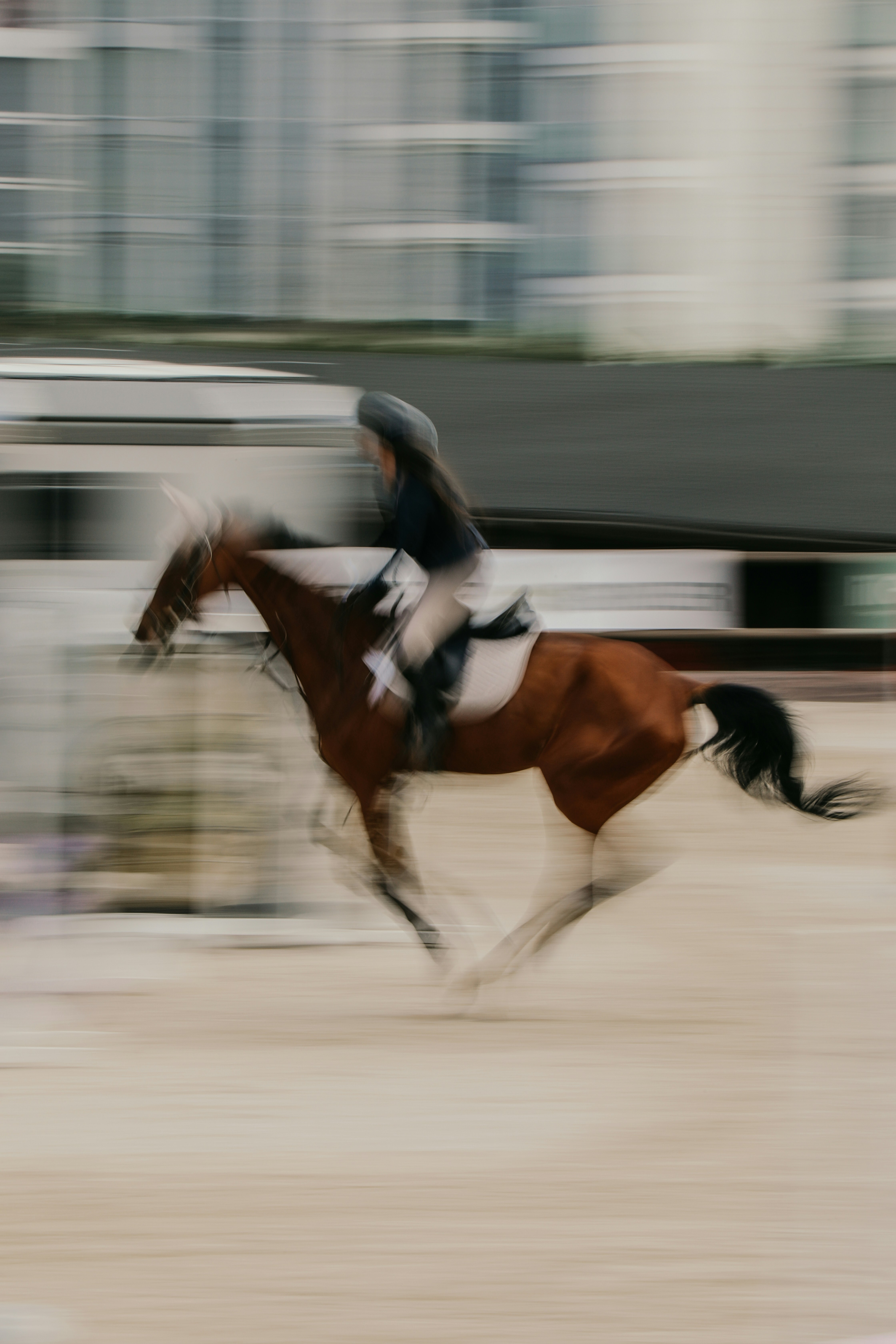 Racing Shadow: A Rider in Full Flight Across a Blurred Arena