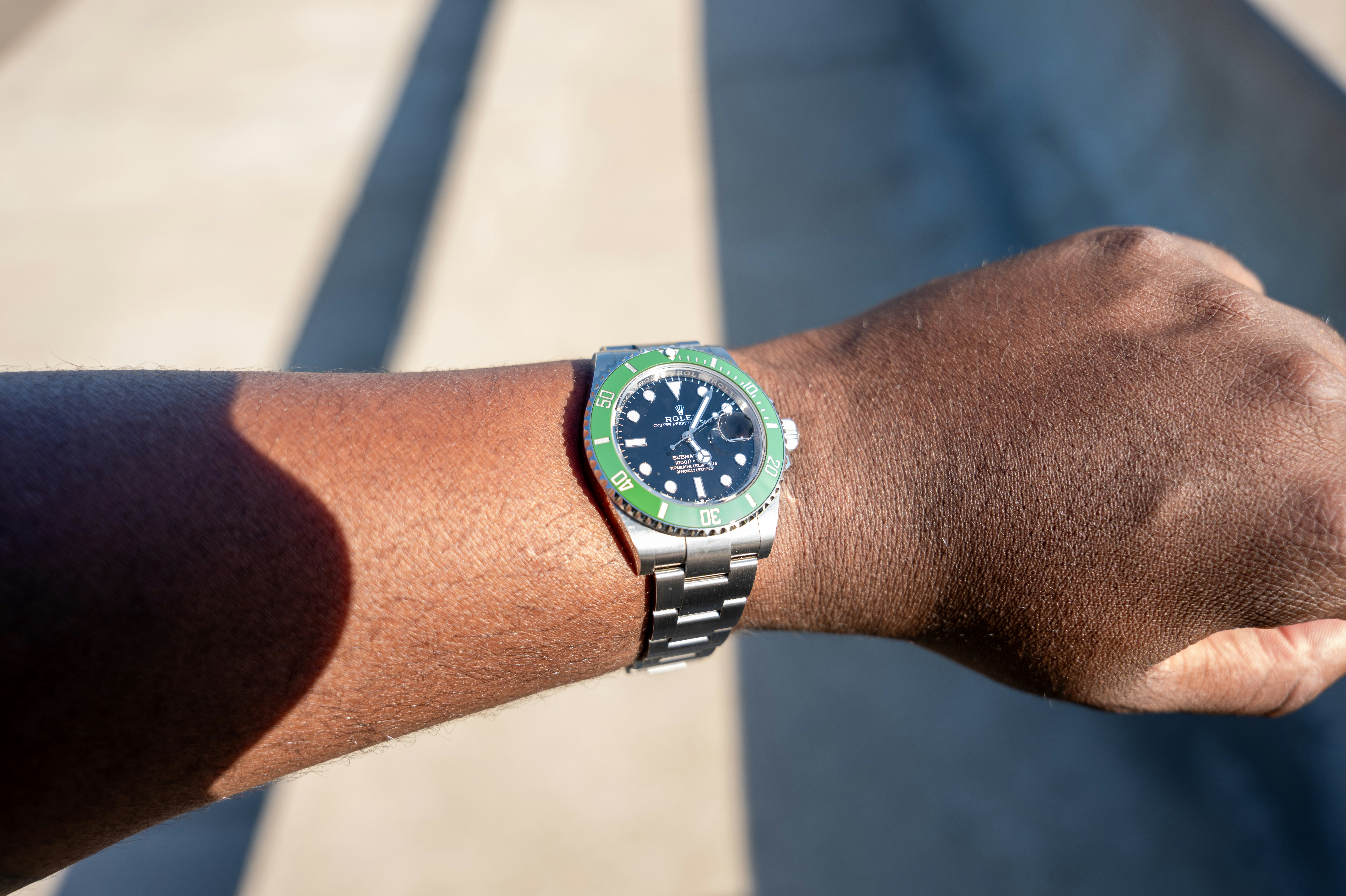Green-bezel Dive Watch on a Sunlit Wrist