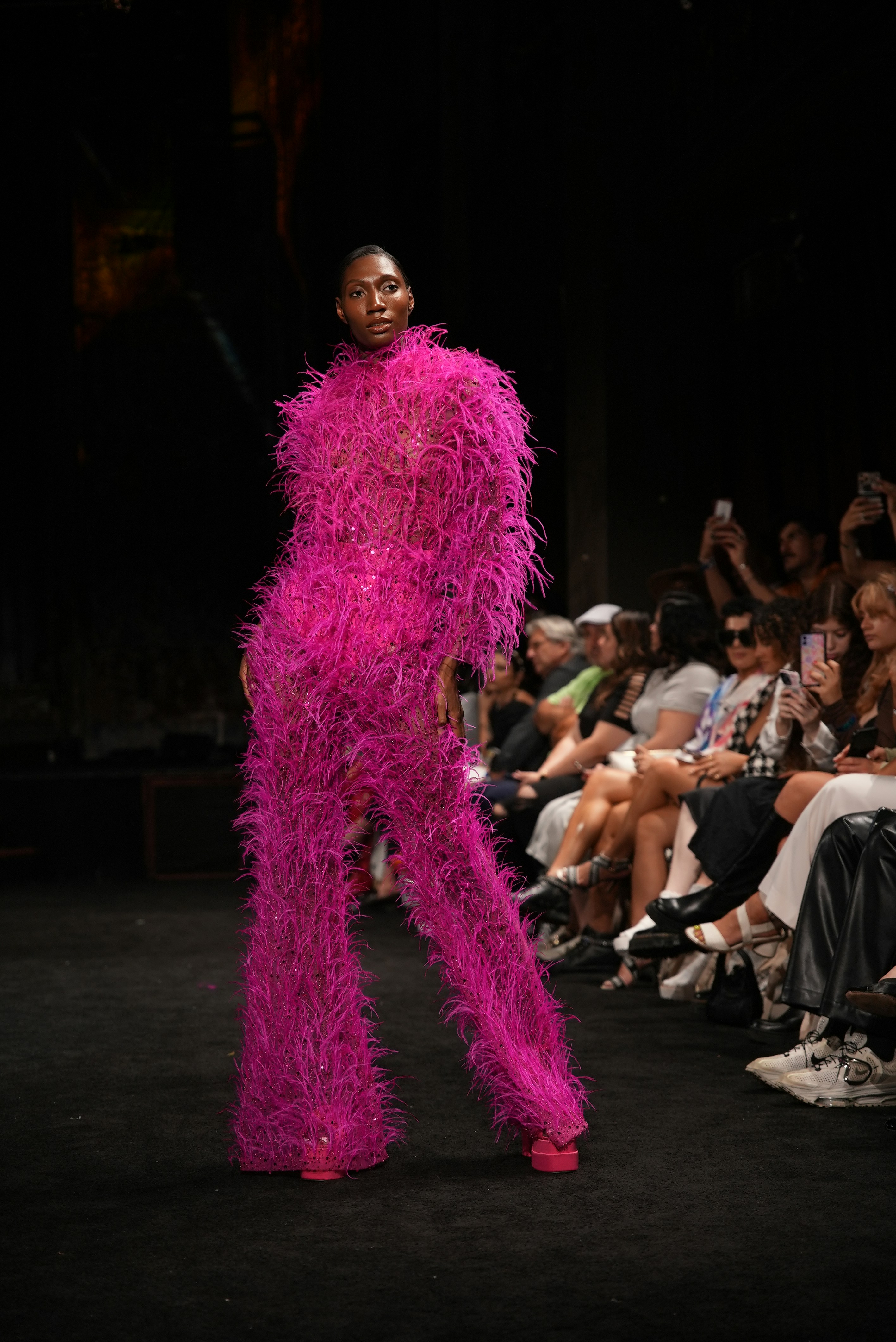 Magenta Feathered Runway: A Bold Figure Struts the Spotlight