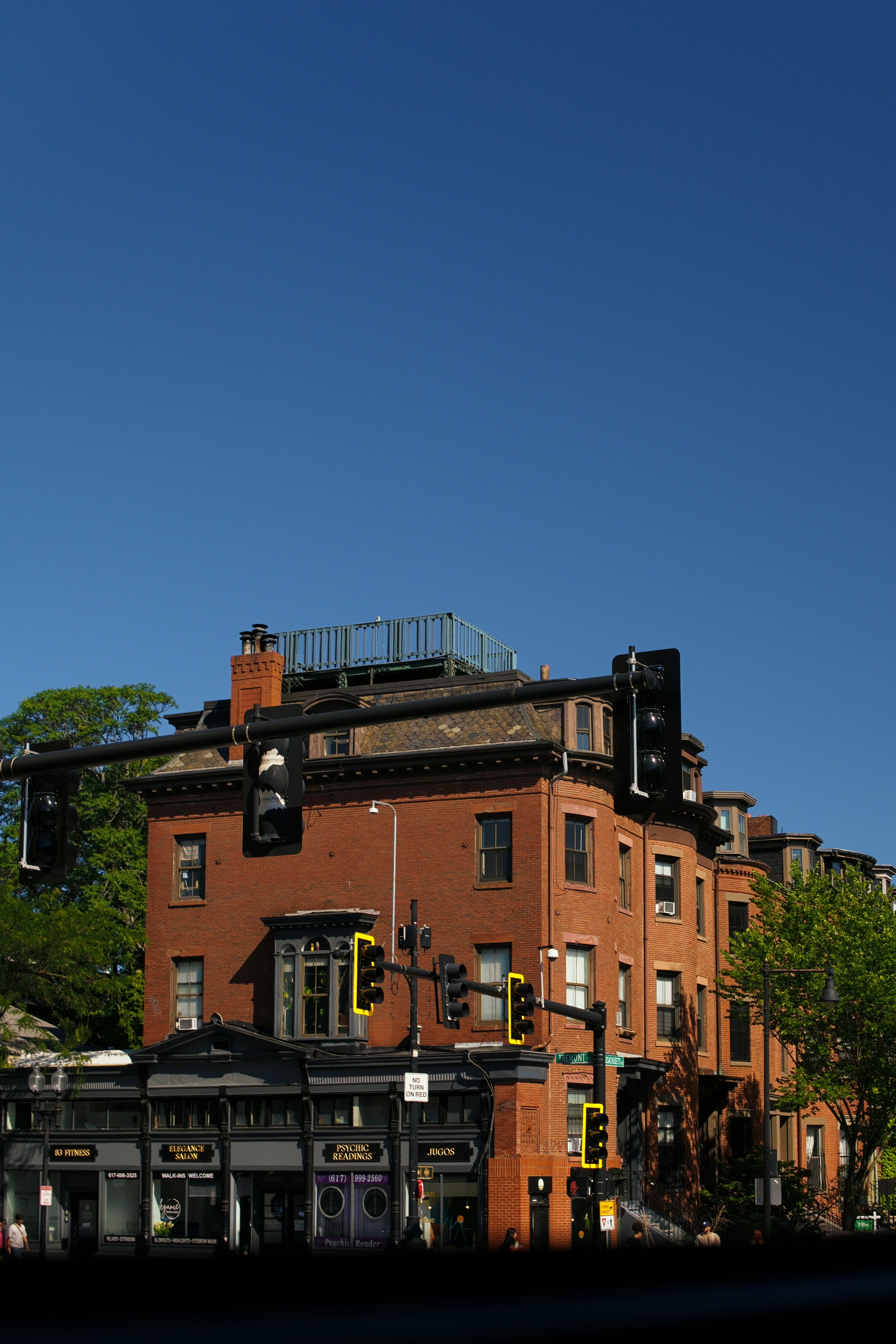 Brick Corner: Urban Facade under a Clear Blue Sky