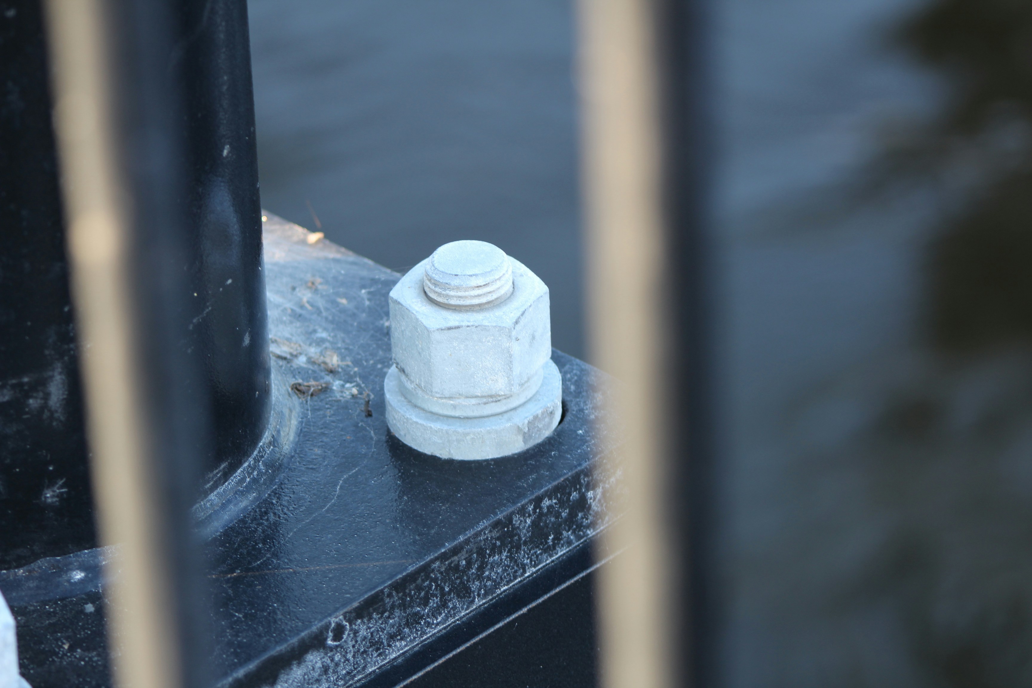 Bolt on a Bridge Structure: Close-Up of a Nut Amid Sturdy Metalwork