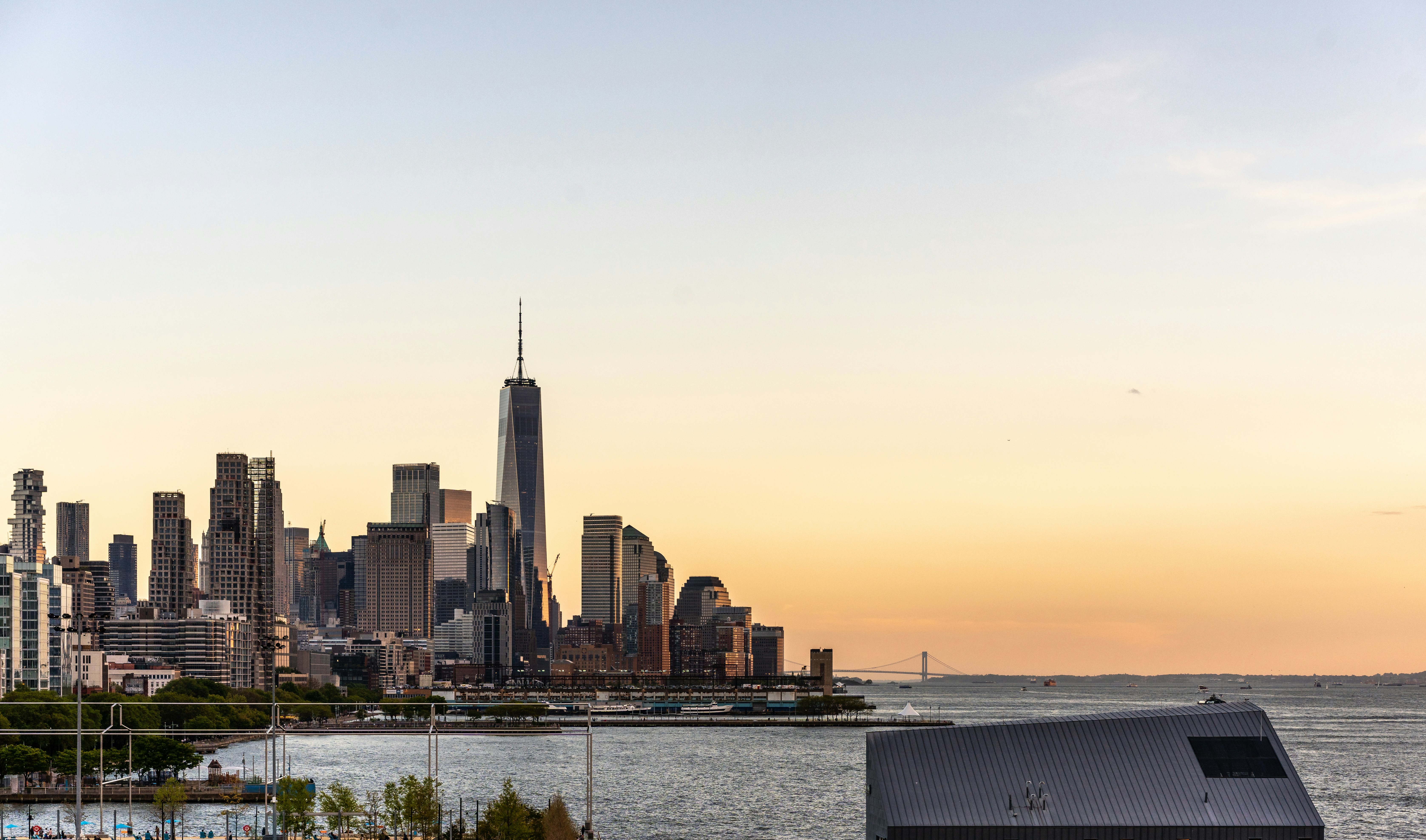 Sunset Skyline: A Calm Coastal City Emerges Over the Water