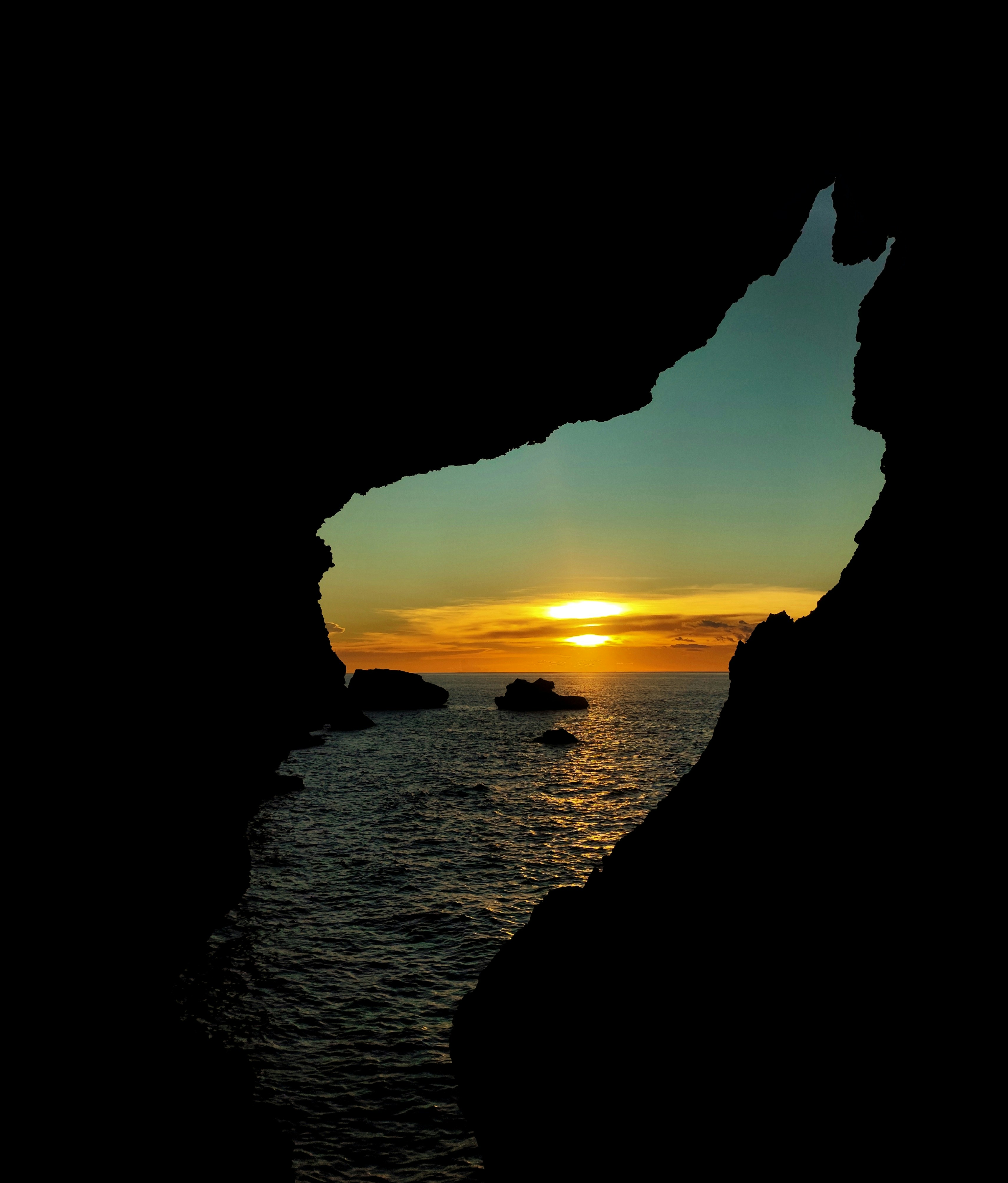 Sunlit Horizon Framed by a Coastal Cave
