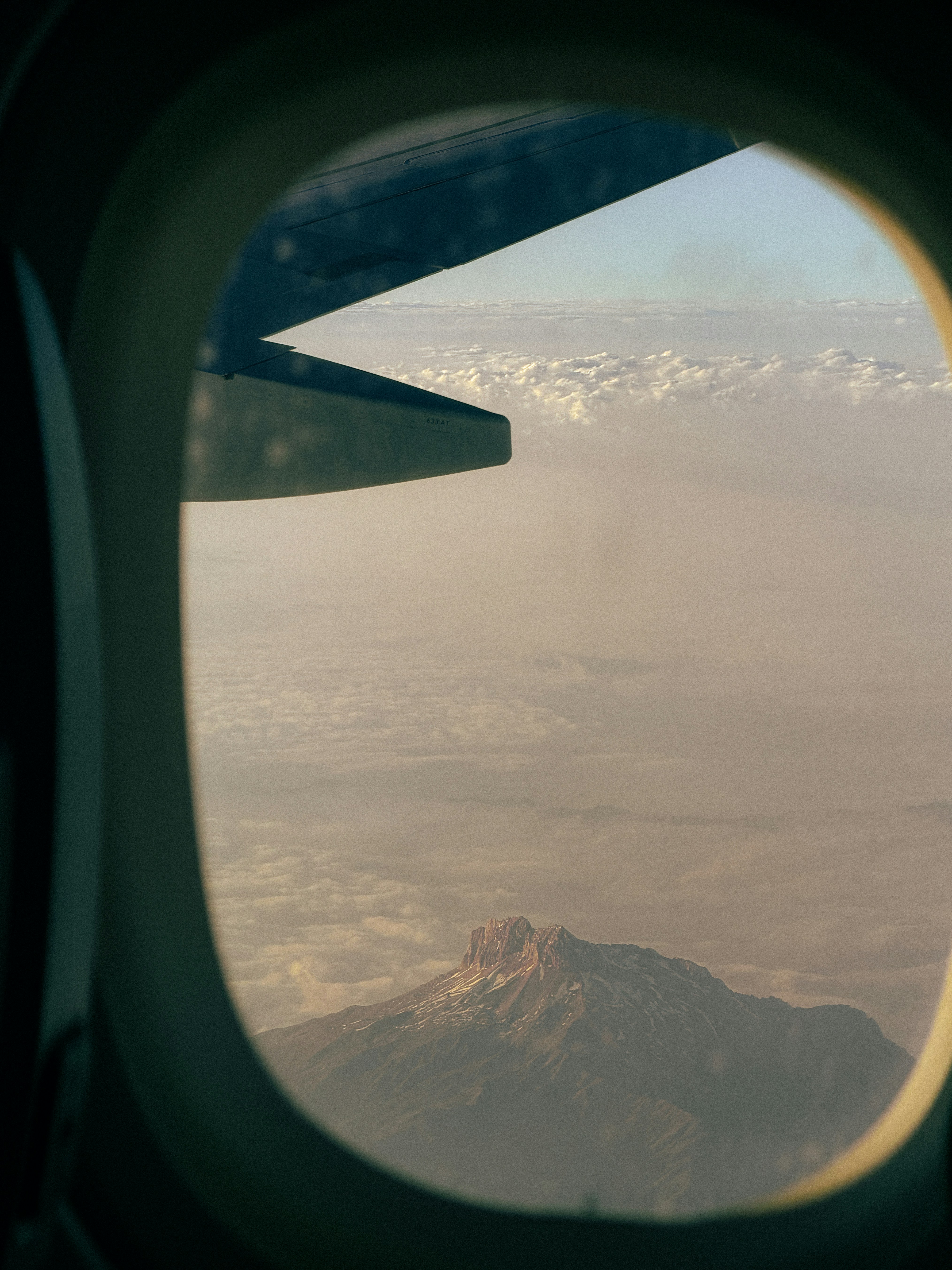 Aerial Vista: Wingtip Above the Mountain Edge