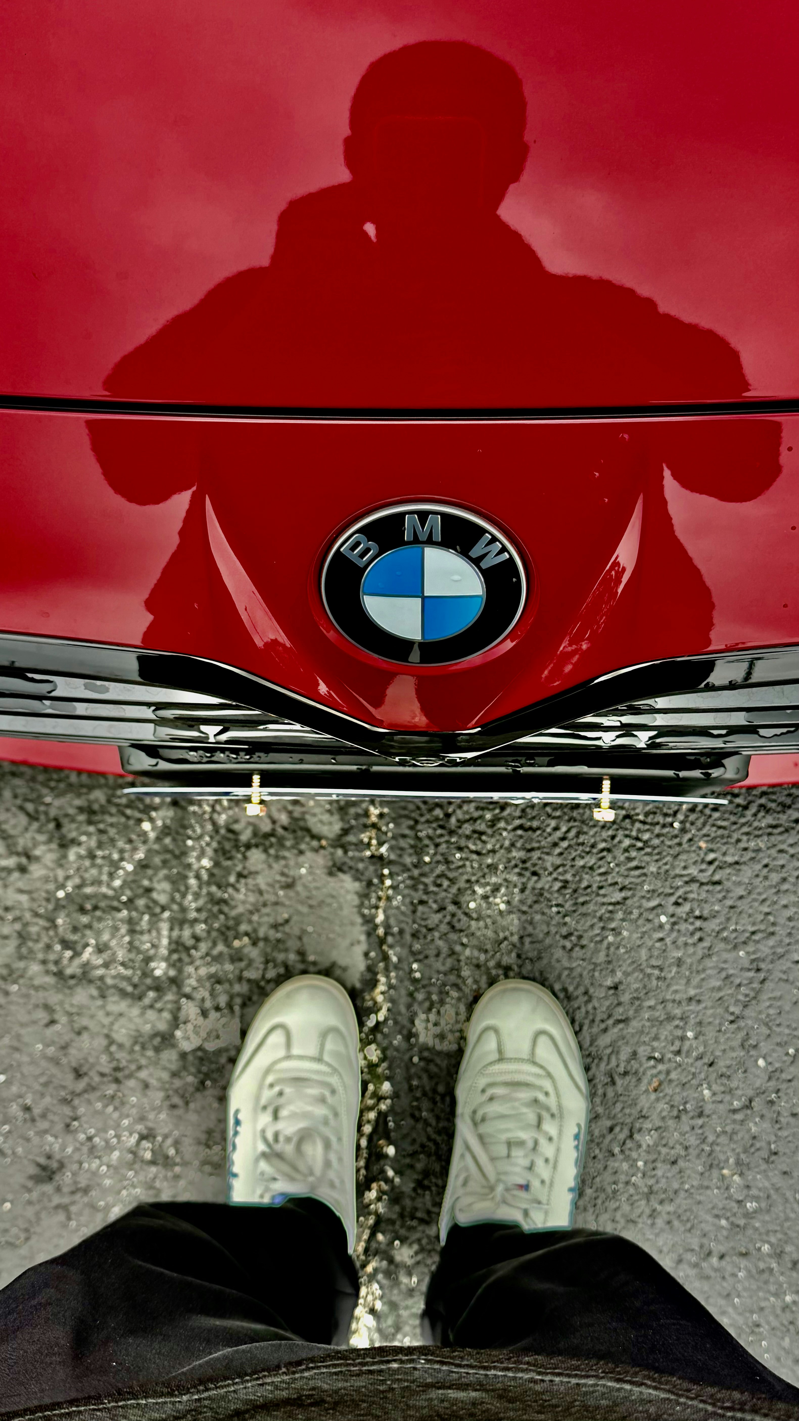 Red BMW Reflection: Boots, Car, and Ground Snap