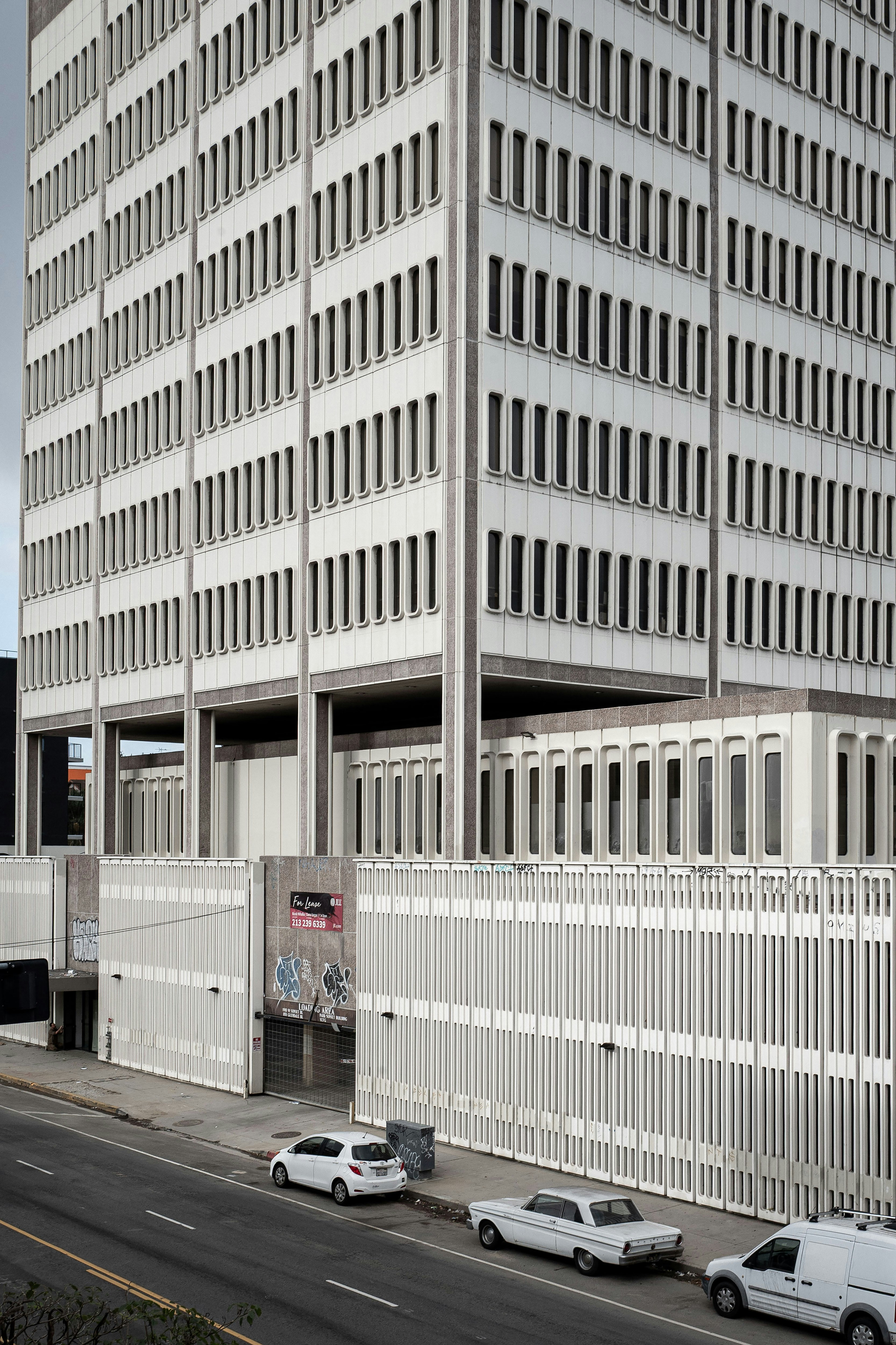 Concrete Grid: An Urban Facade Rising Over a Quiet Street
