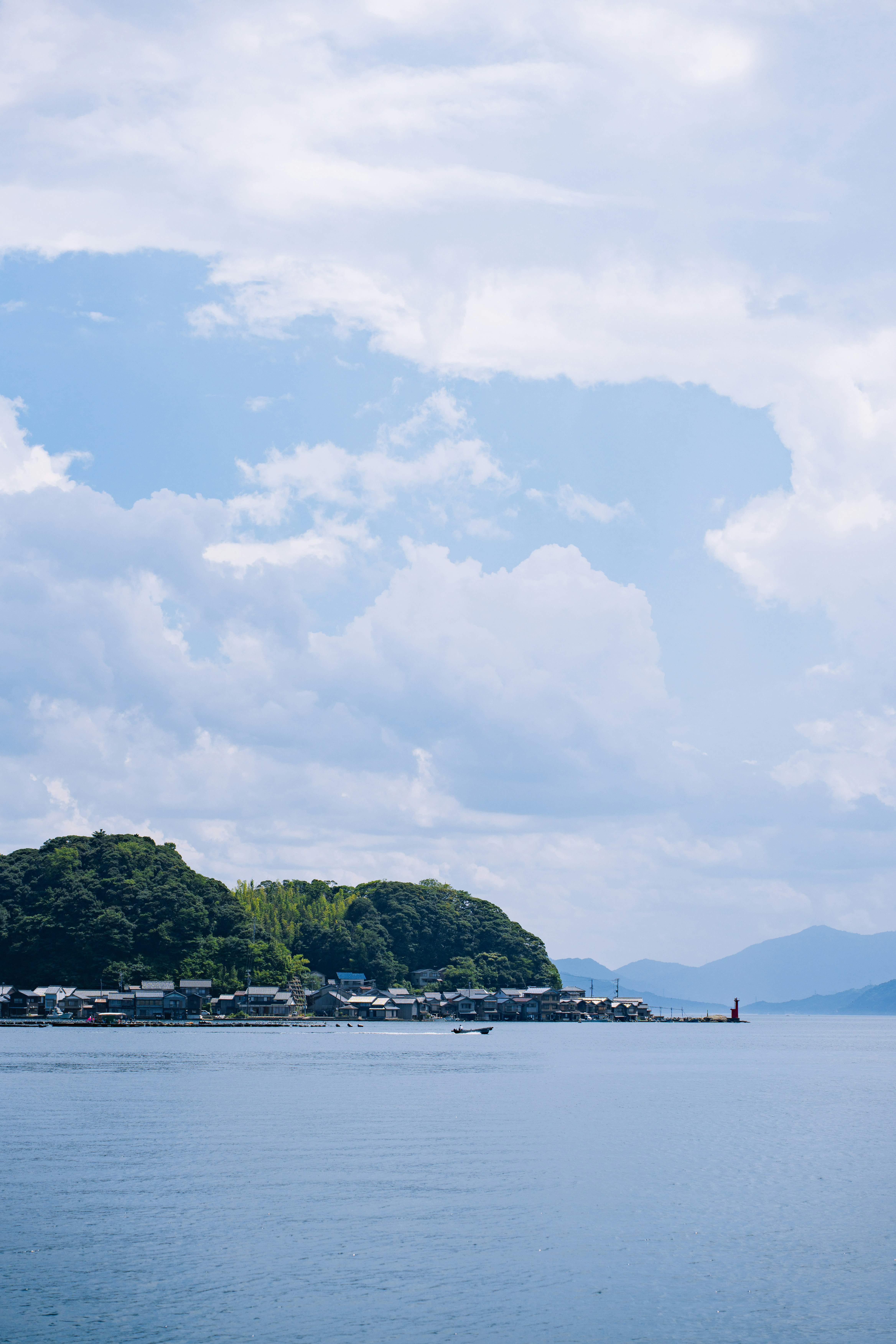 Coastal Village Silhouette Under Expansive Sky