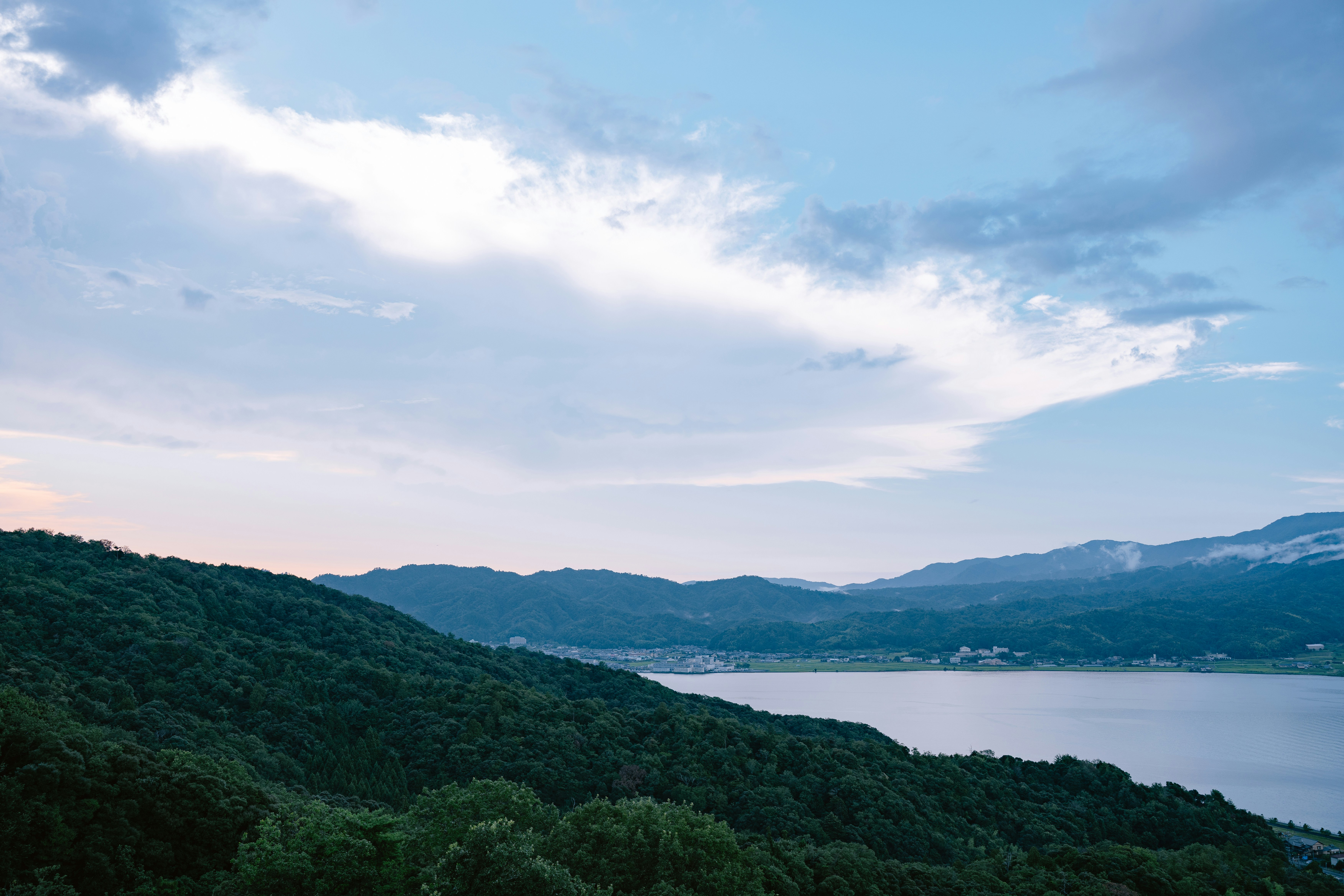 Vast Lake Echoes: Hills, Water, and Sky