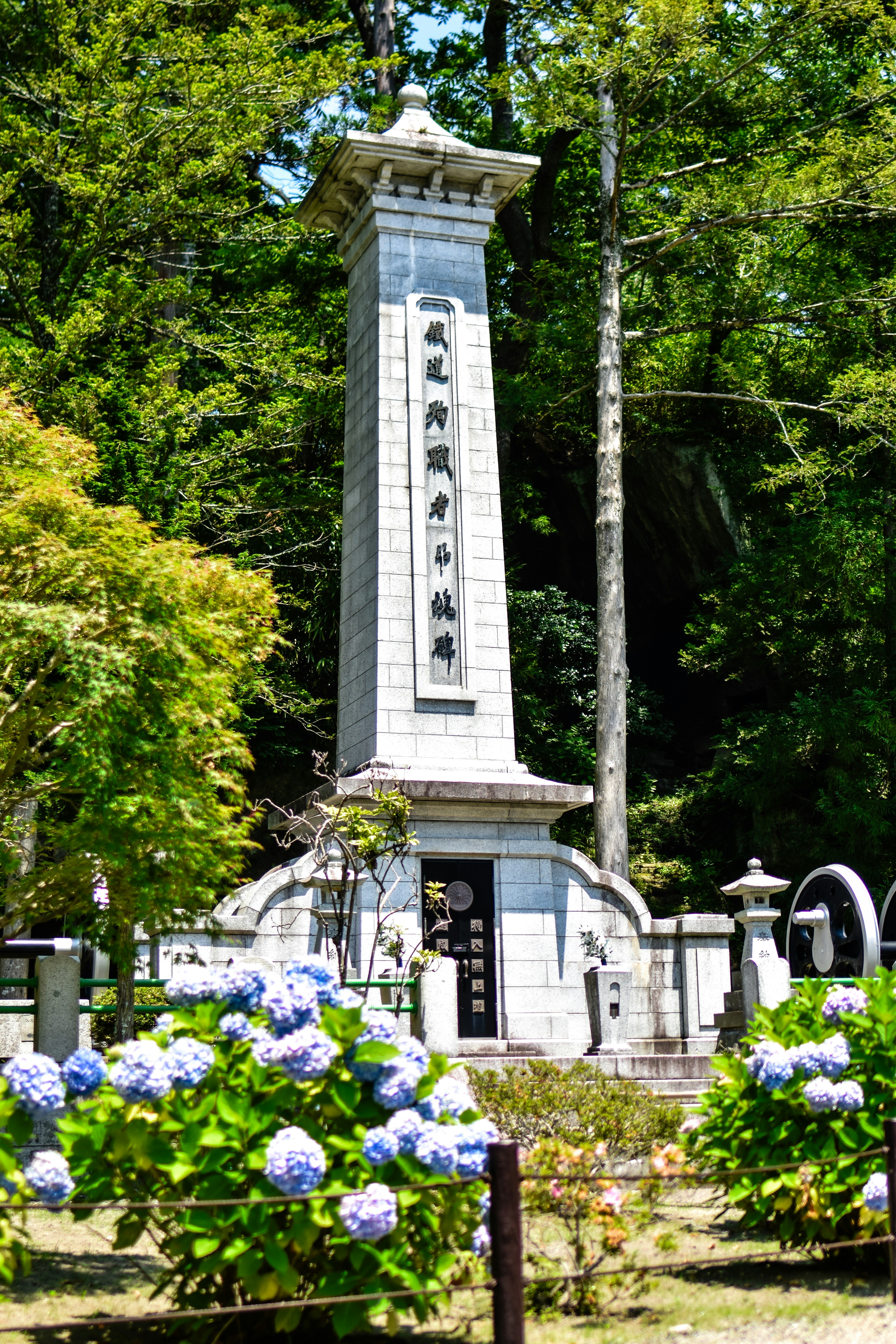 Stone Obelisk Framed by Garden Blooms