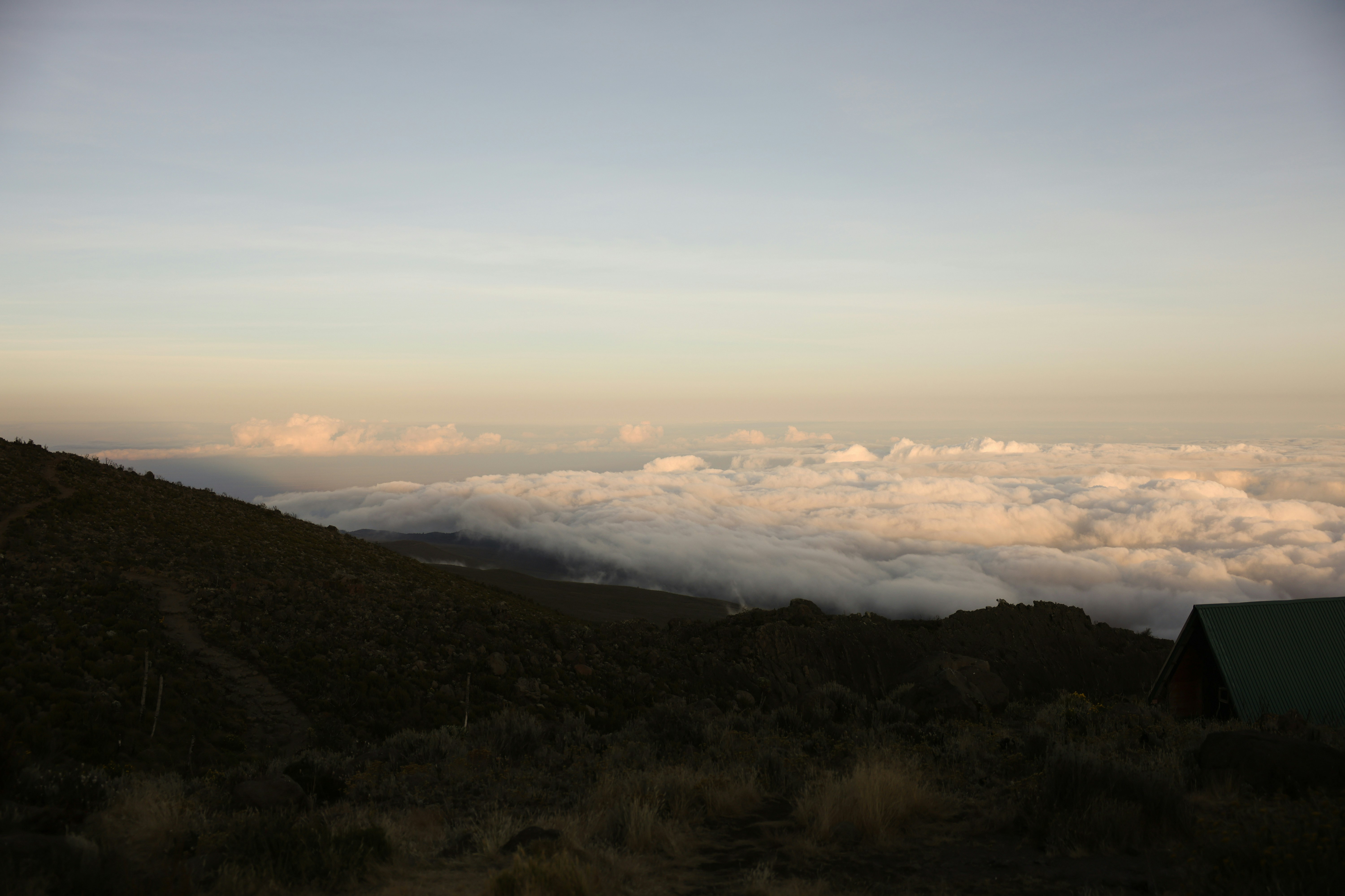 Dawn over the Ridge: Clouds Rolling Beyond the Slope