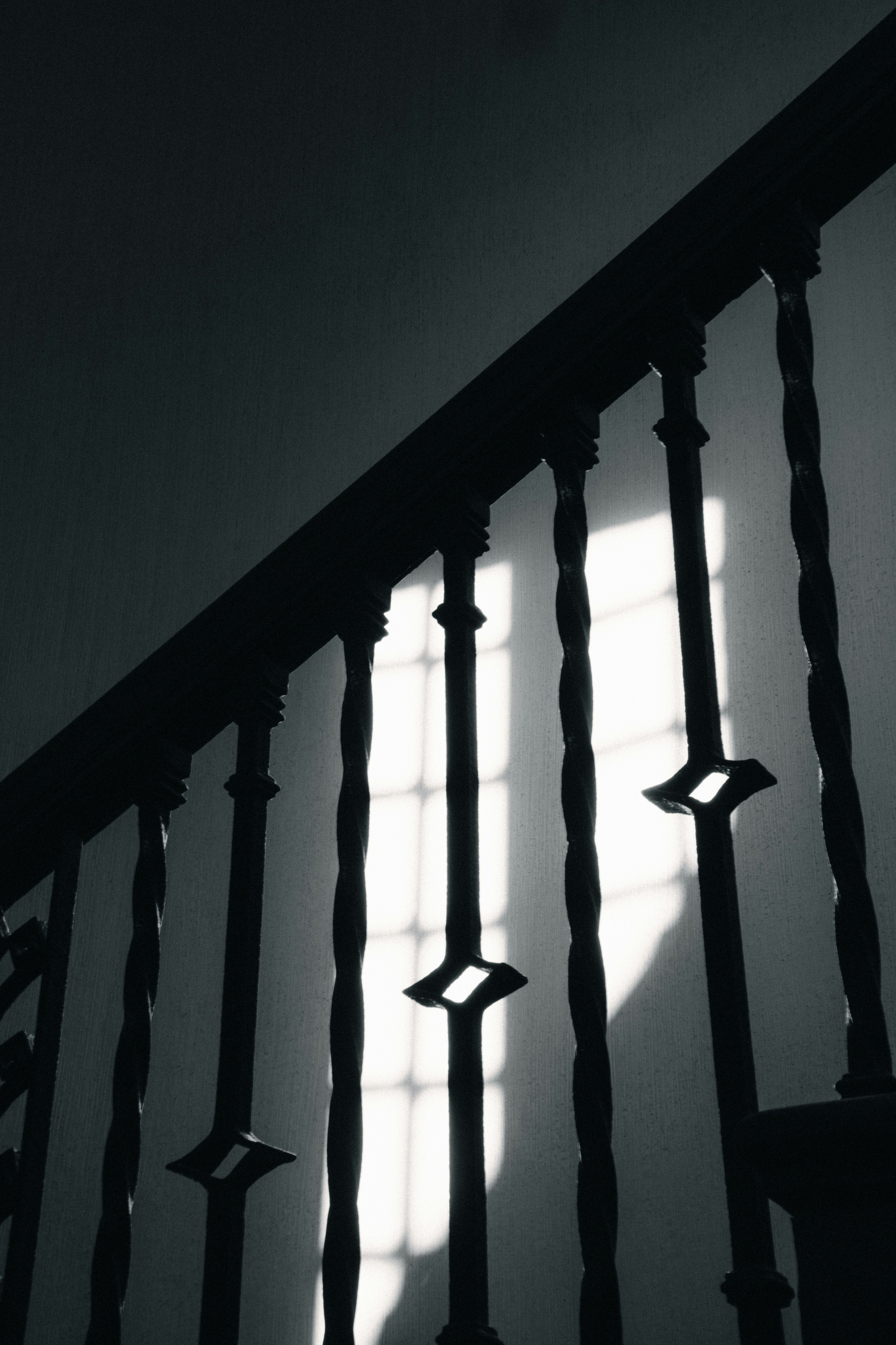 Shadowed Staircase: Iron Balusters Casting Geometric Light