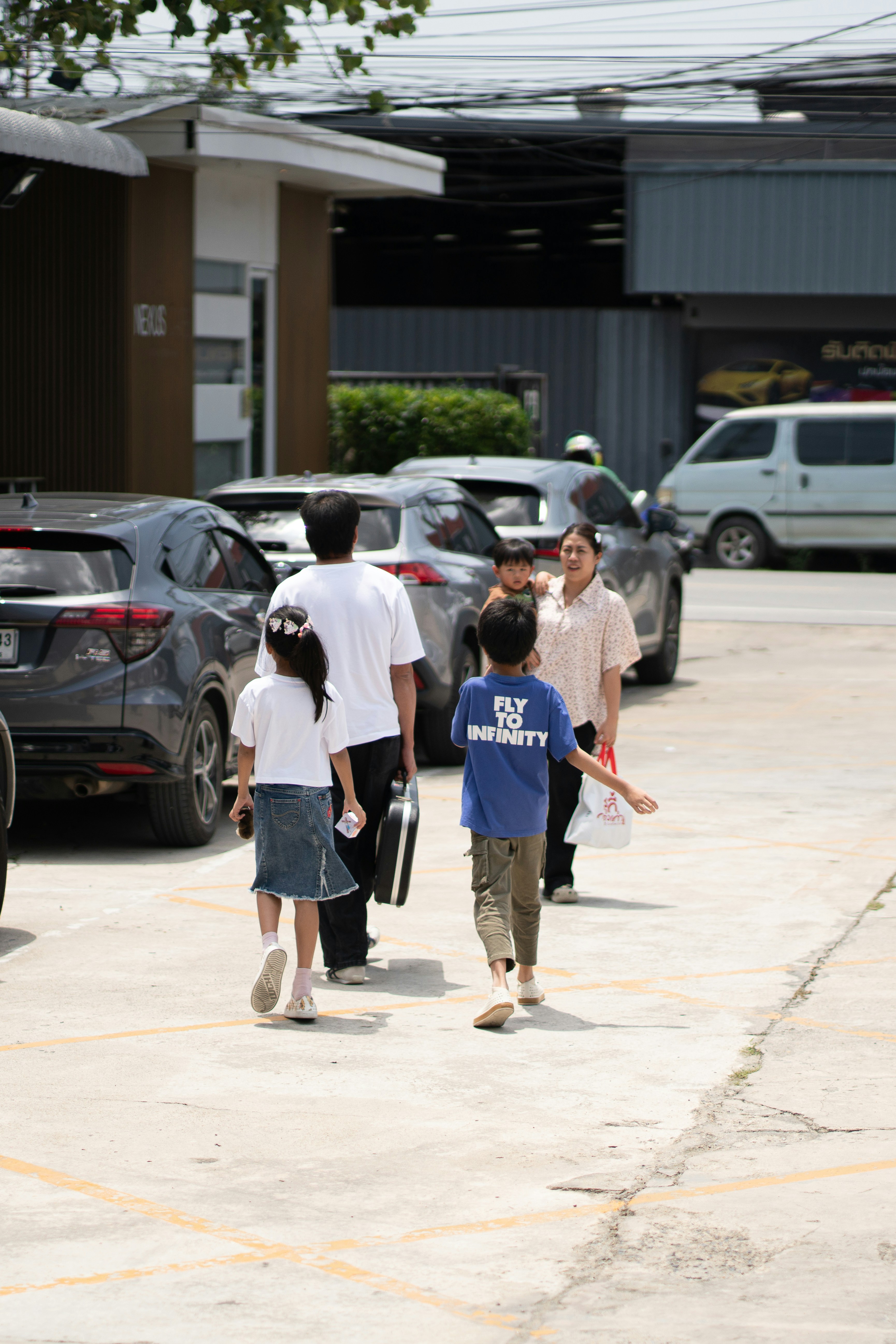 Family Crossing the Parking Lot: A Moment of Movement and Interaction