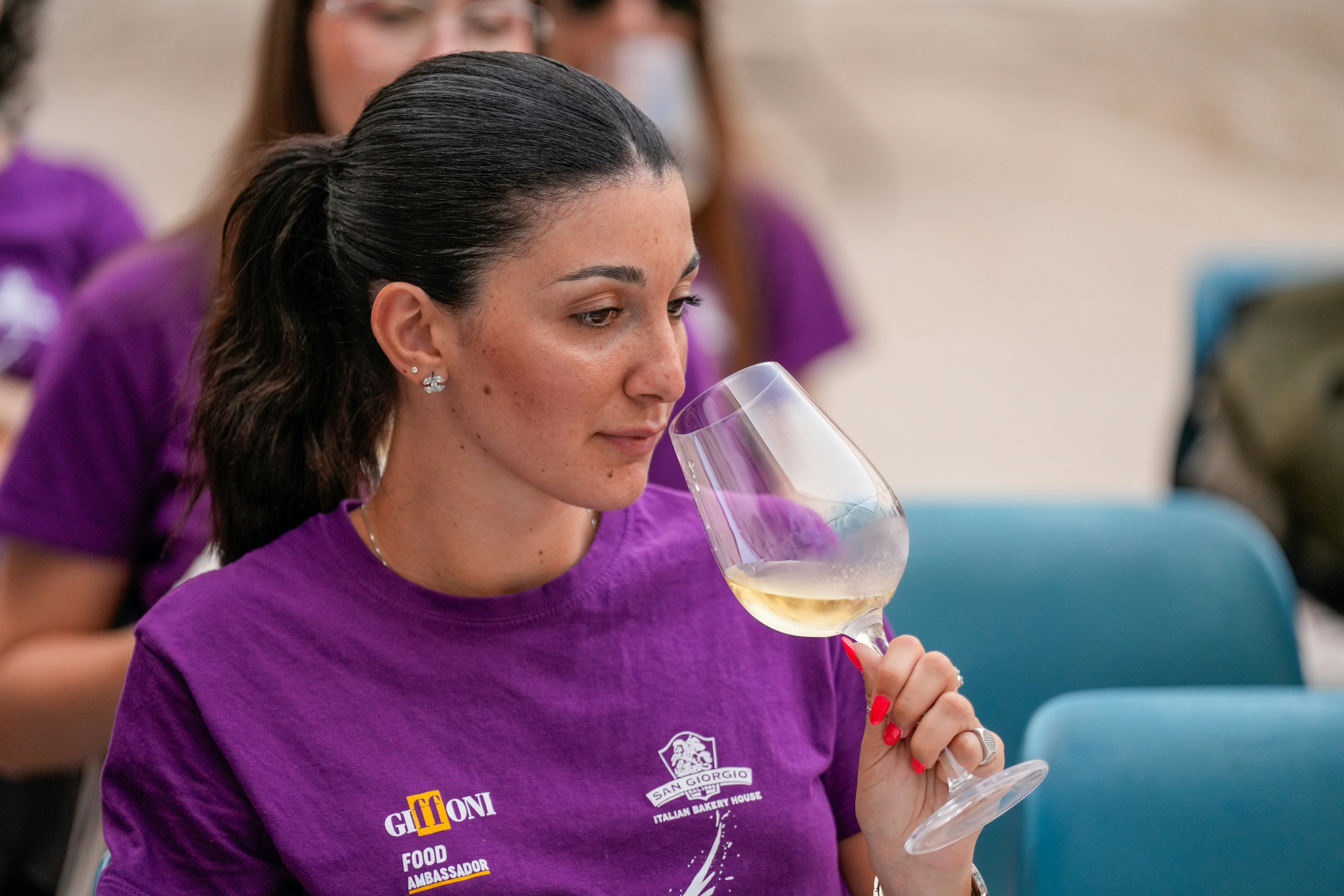 Sipping Focus: A contemplative moment with wine and purple crew