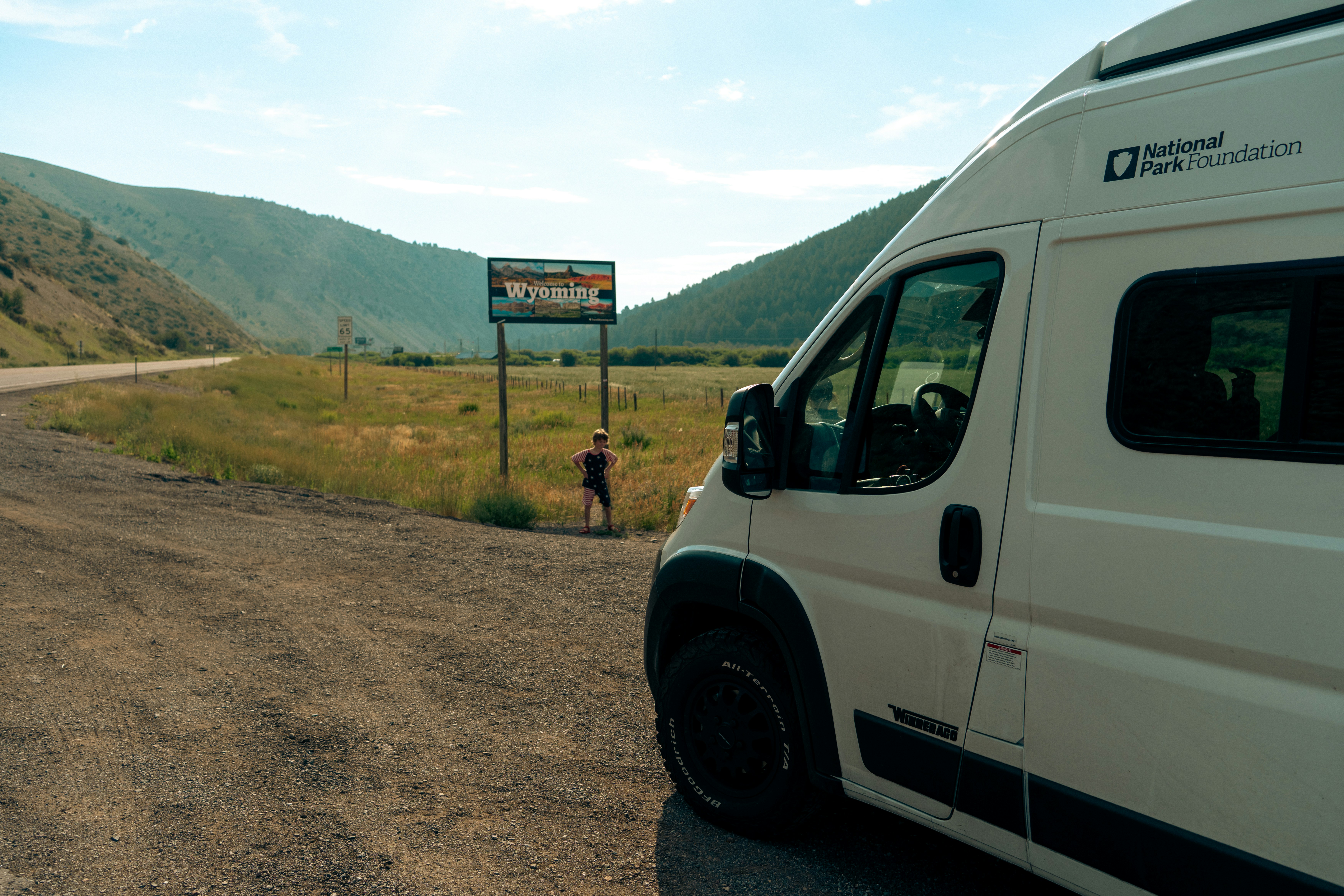 Rugged Roadside Fade: A White Van at Wyoming Horizon