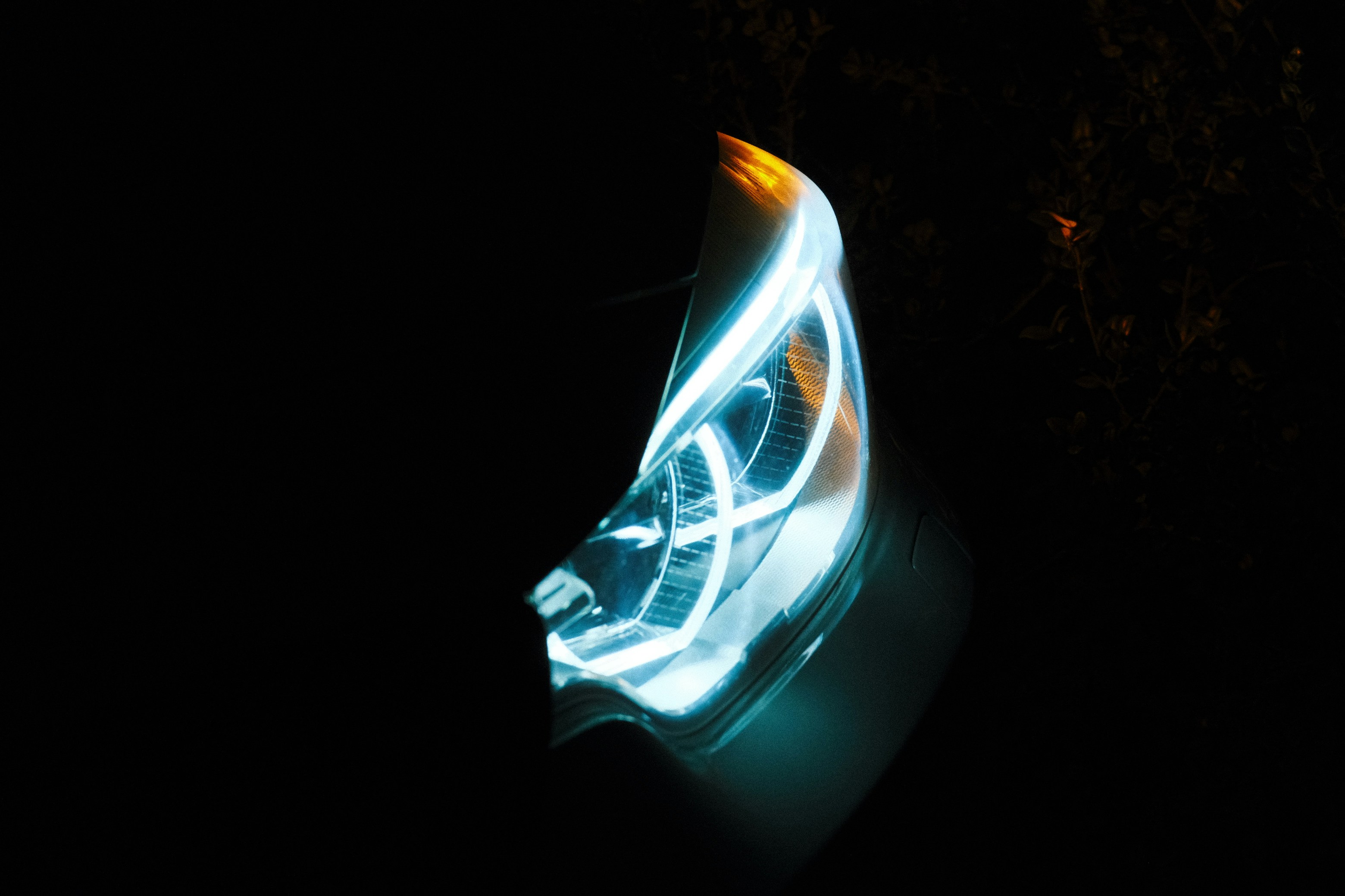 Glowing Headlight in the Night: An Abstract Car Portrait