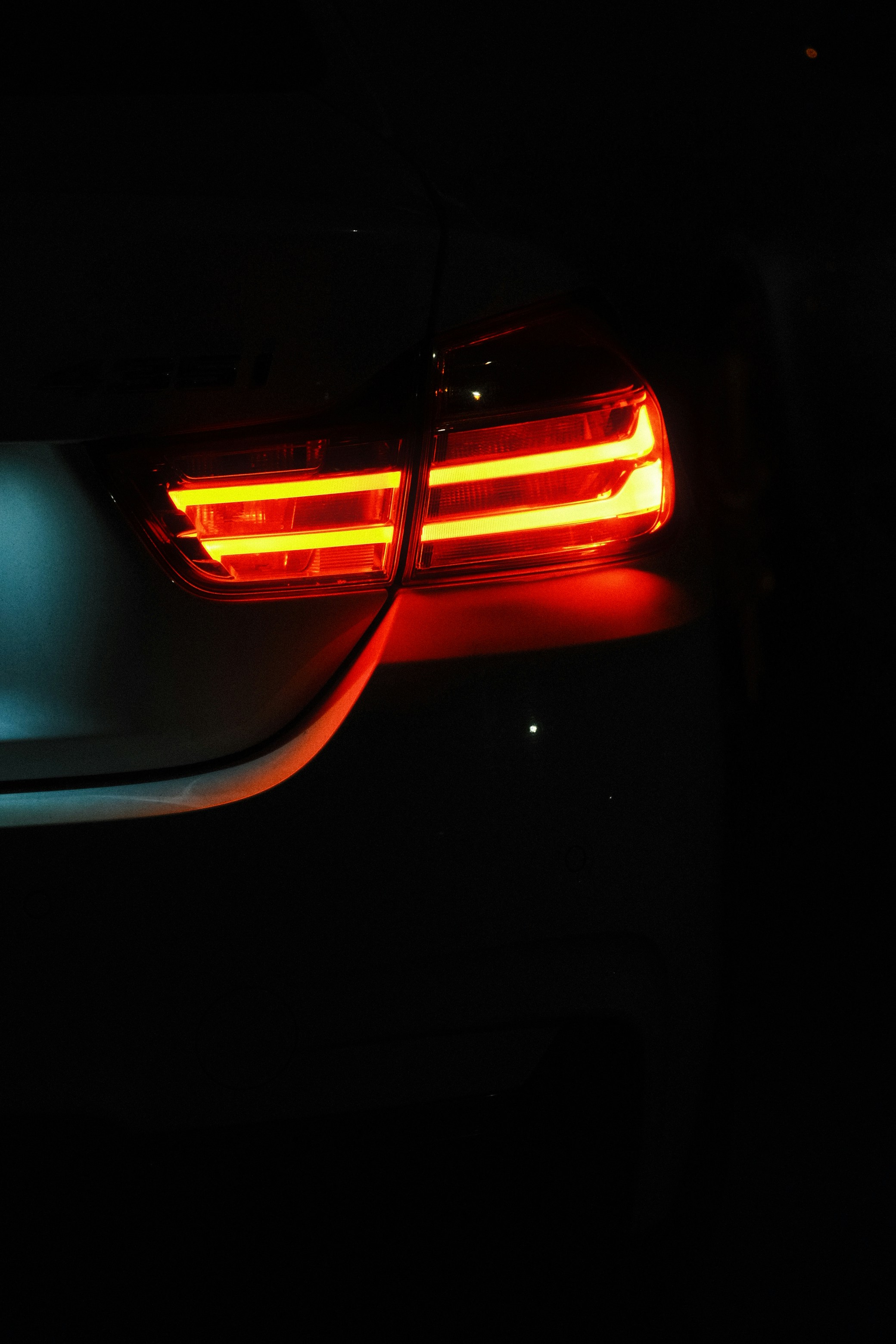 Neon Tail Light Glow: A Car's Quiet Night Portrait