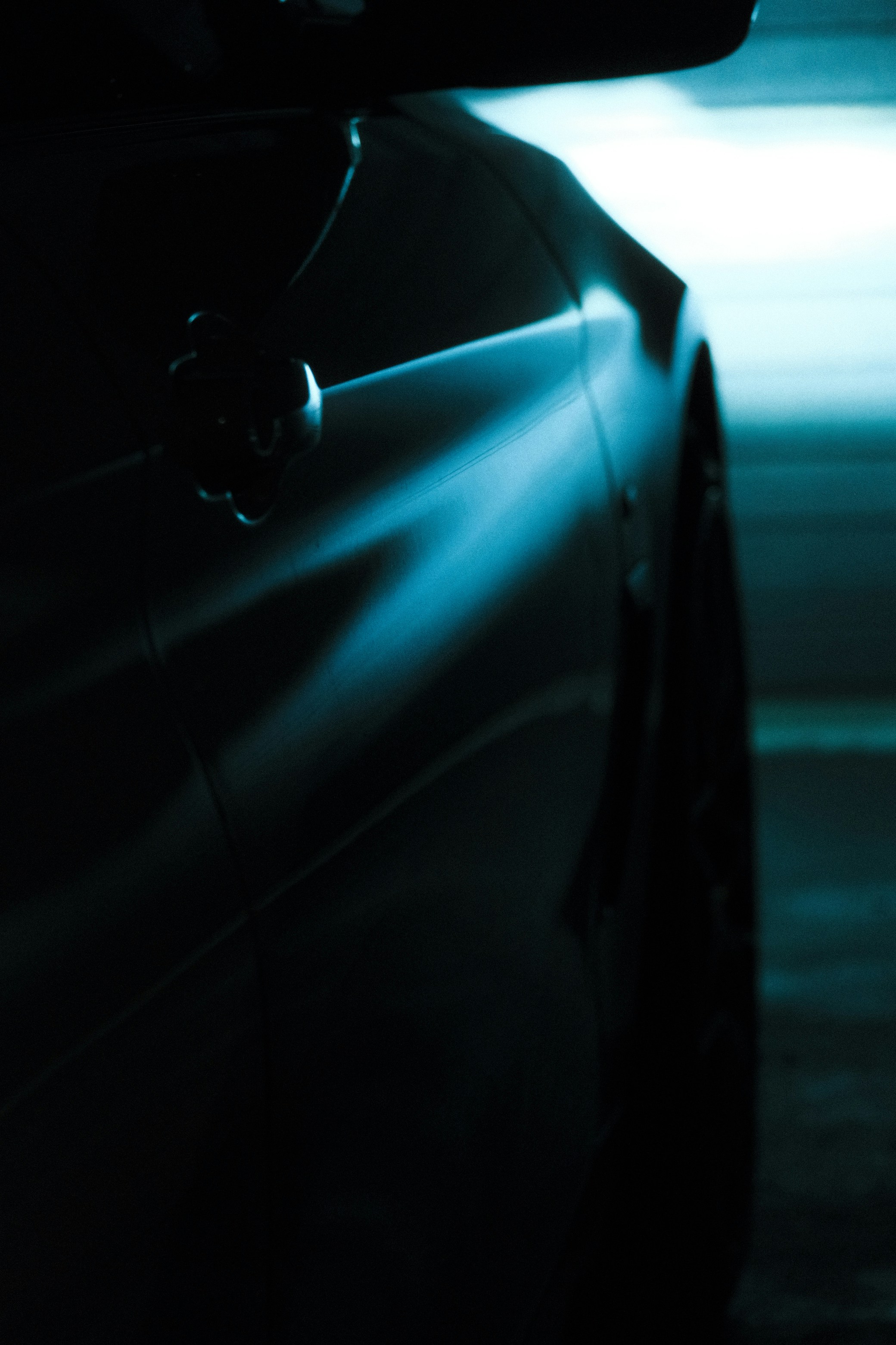 Blue-tinted Side Profile of a Car in a Dim Garage