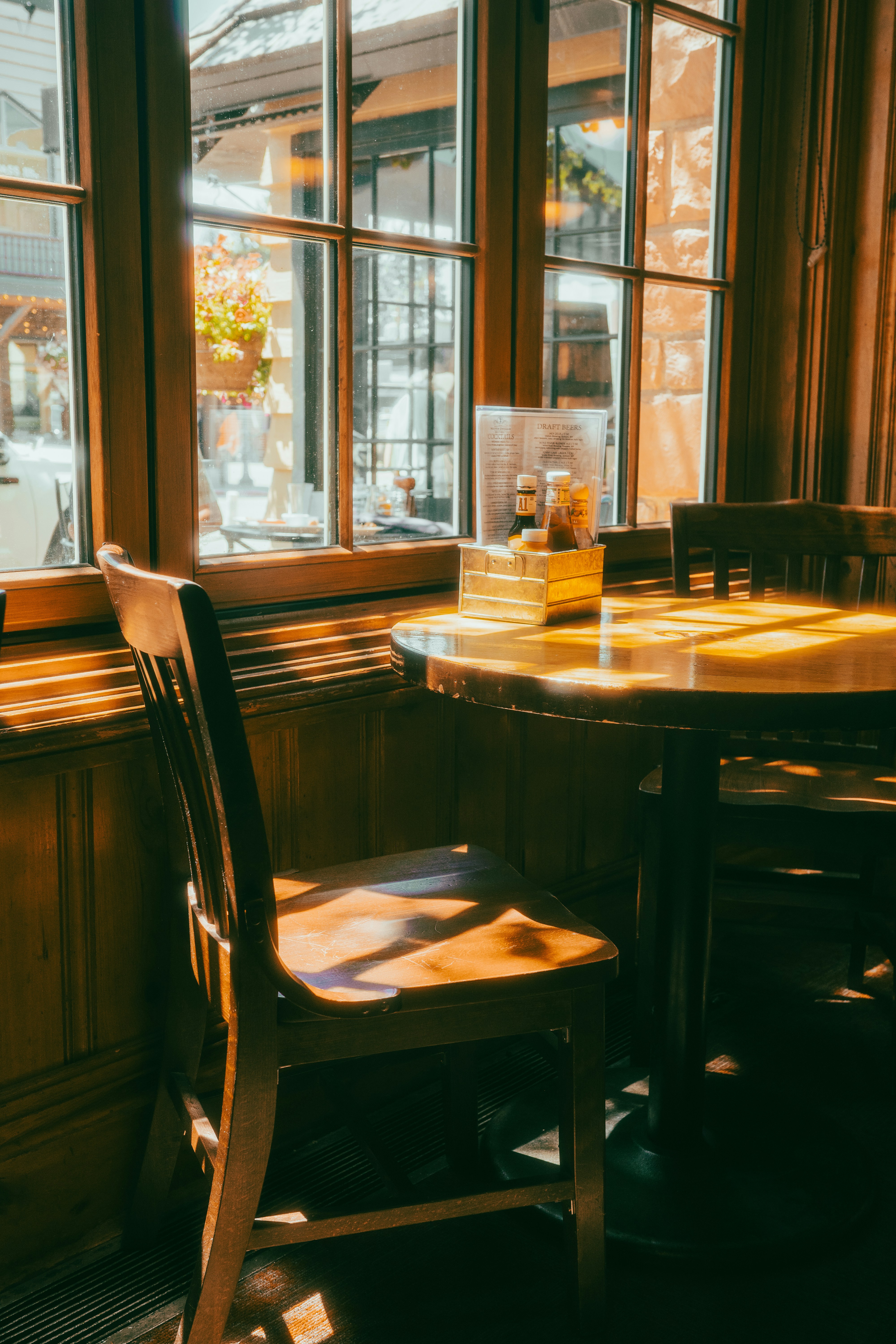 Warm Corner of the Café: Sunlit Corner Table by the Window