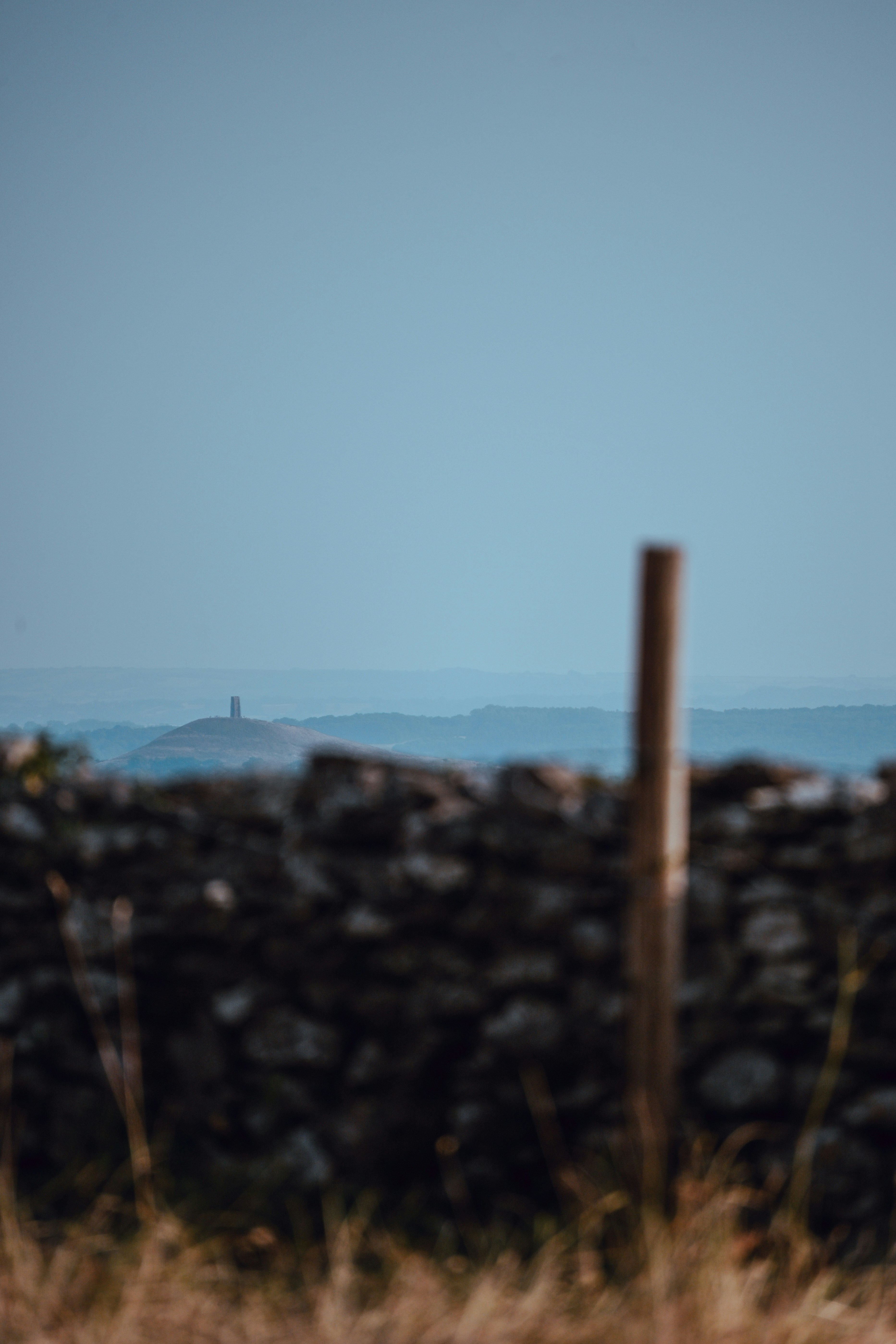 Distant Marker Beyond a Weathered Wall