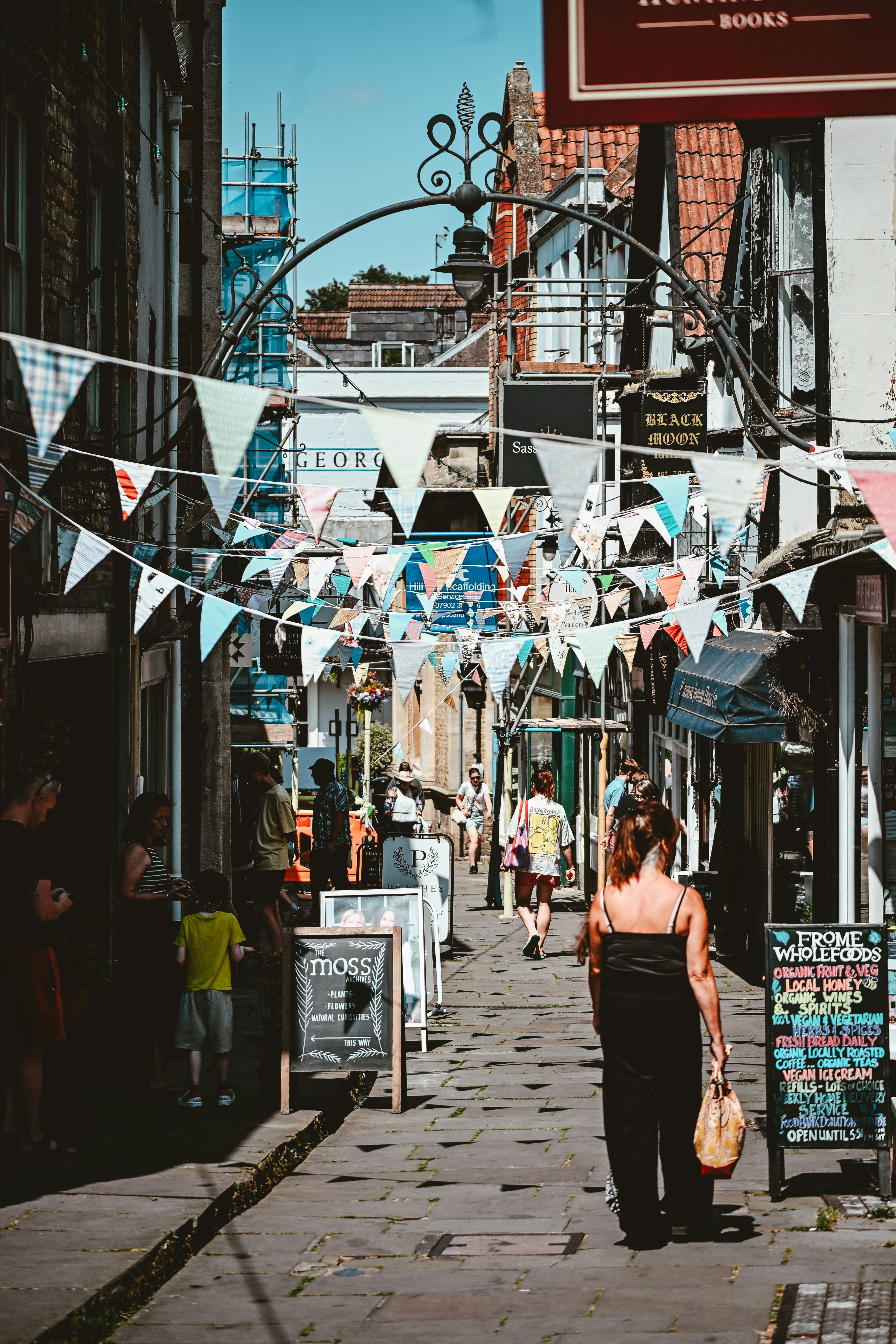 Bunting Over a Cobblestone Lane: A Sunlit Town Walk
