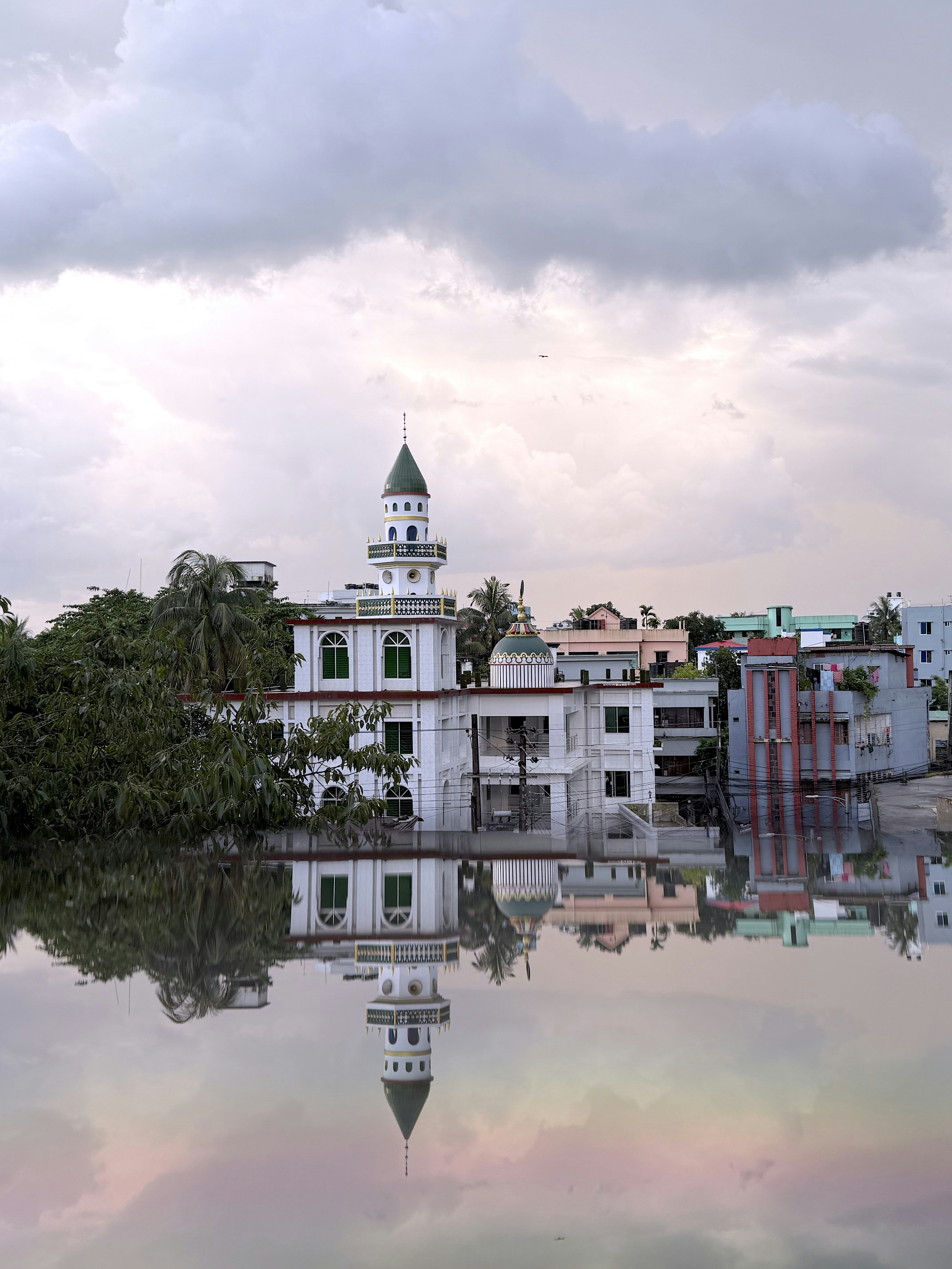 Twin Spires Over Silent Water: A City Mosque Beside the Mirror