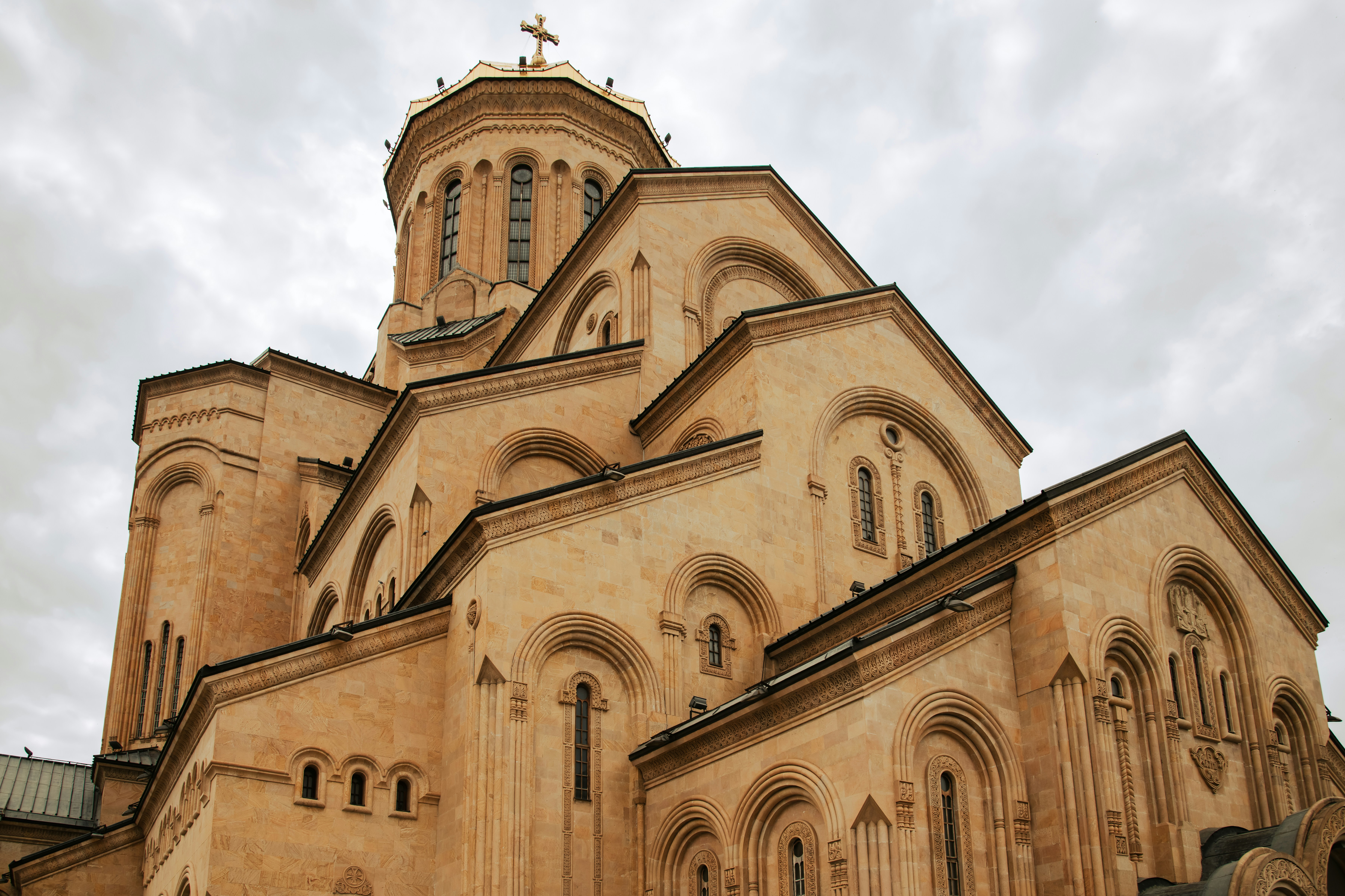 Stone Cathedral Rising: A Warm-toned Facade Under Expansive Sky