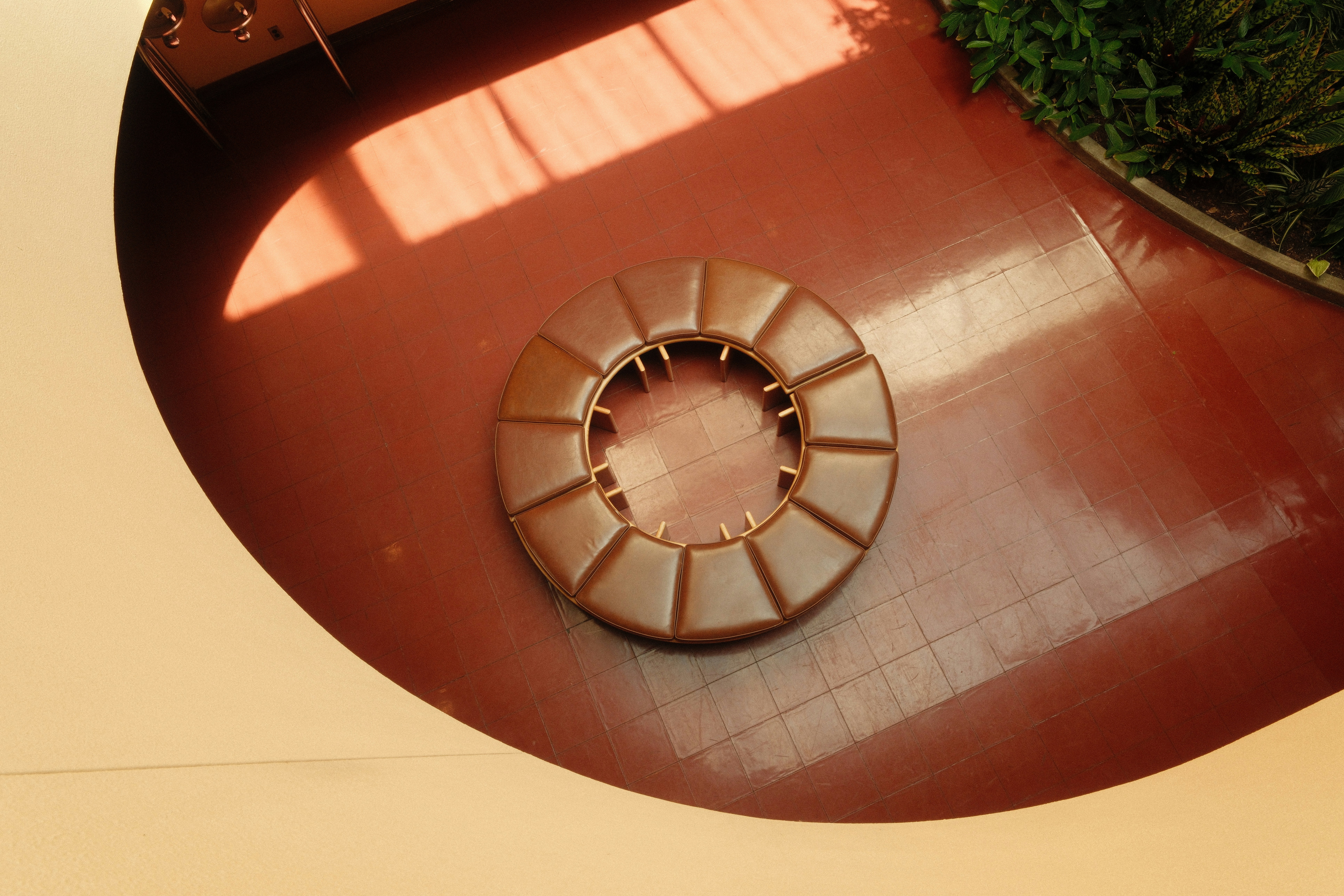 Circular Stairwell Fade: A Top-Down Spiral in Warm Tile