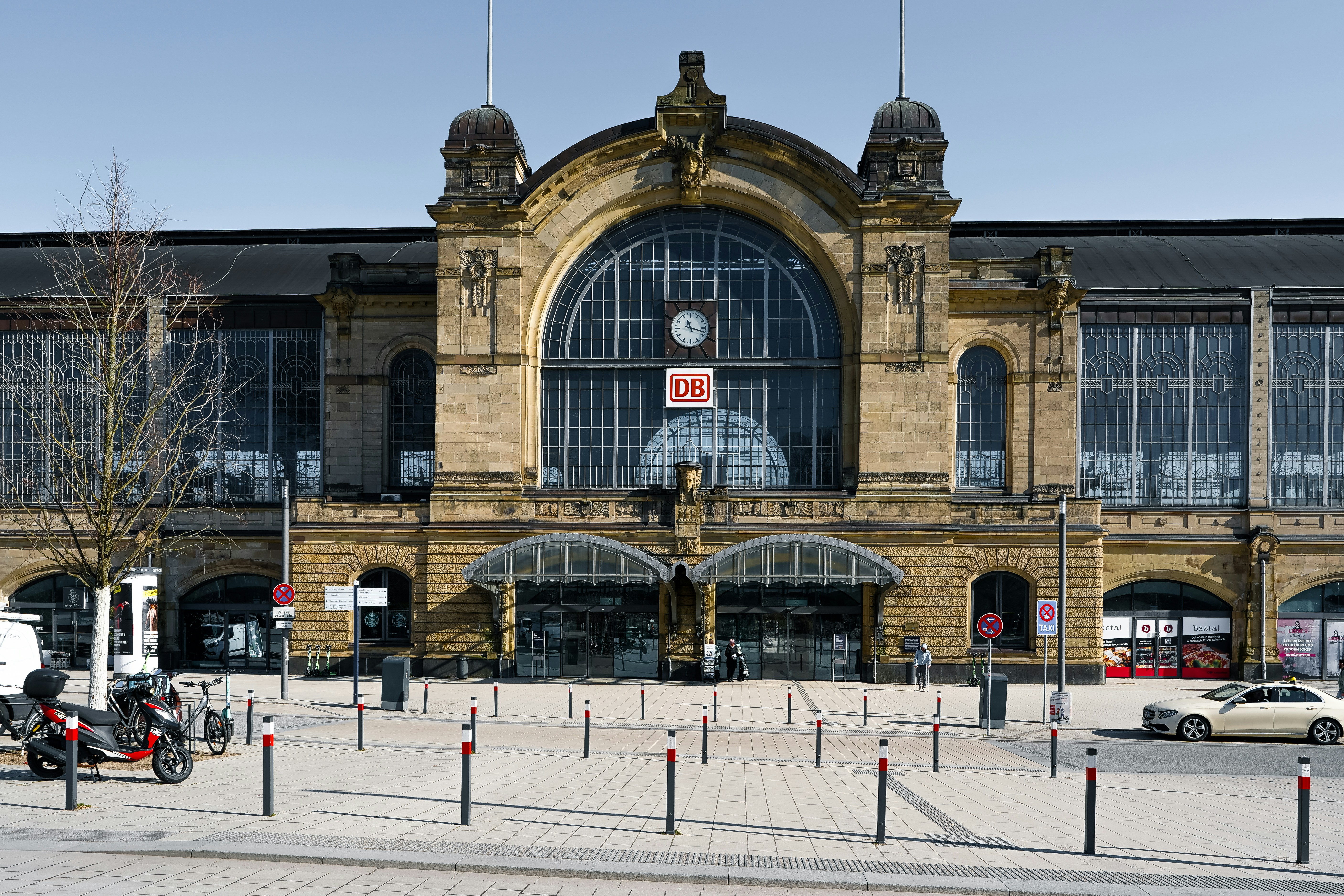 Central Train Station Facade: Clock, Arches, and Street Forecourt