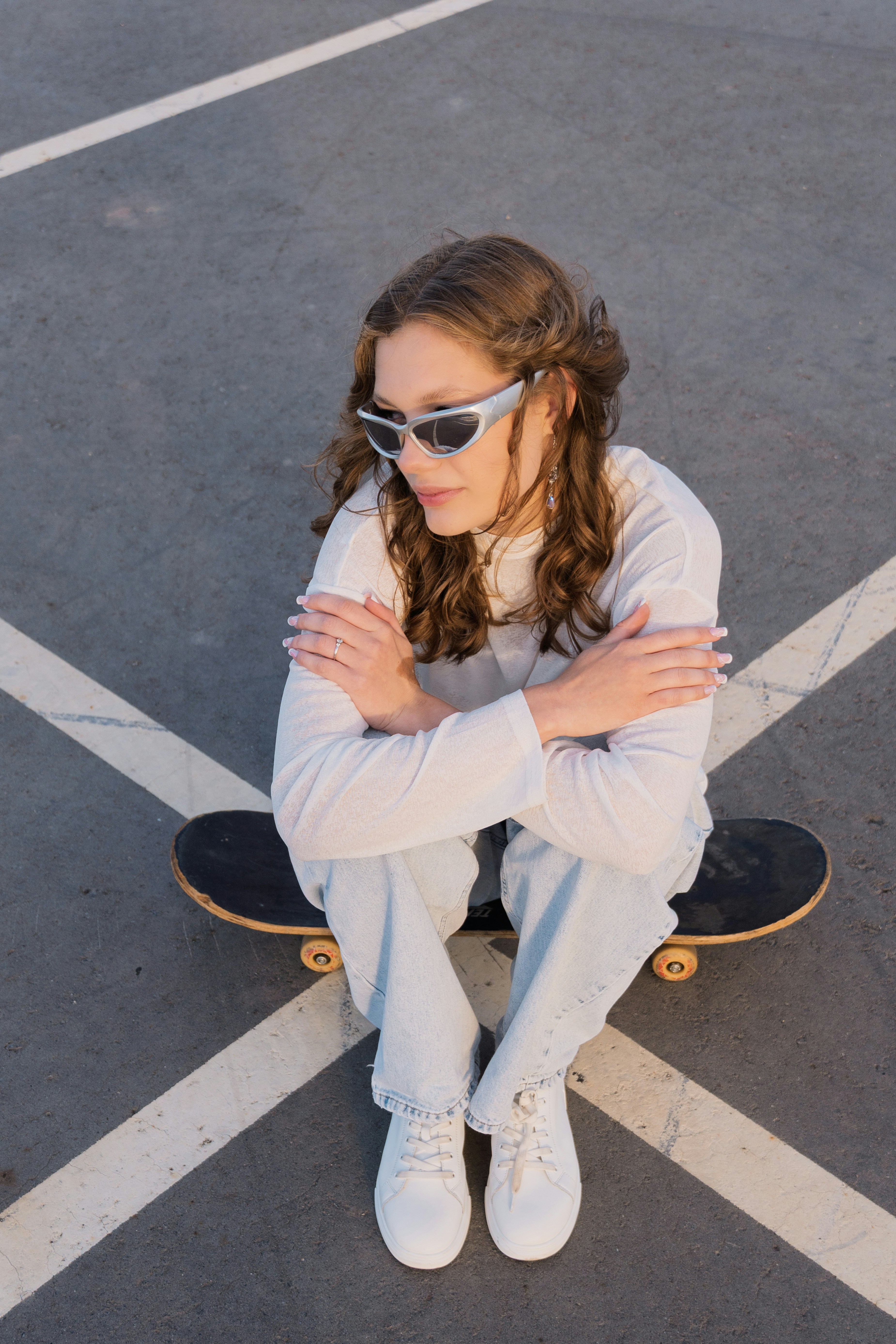 Lone skater perched on a weathered curb, lost in the moment