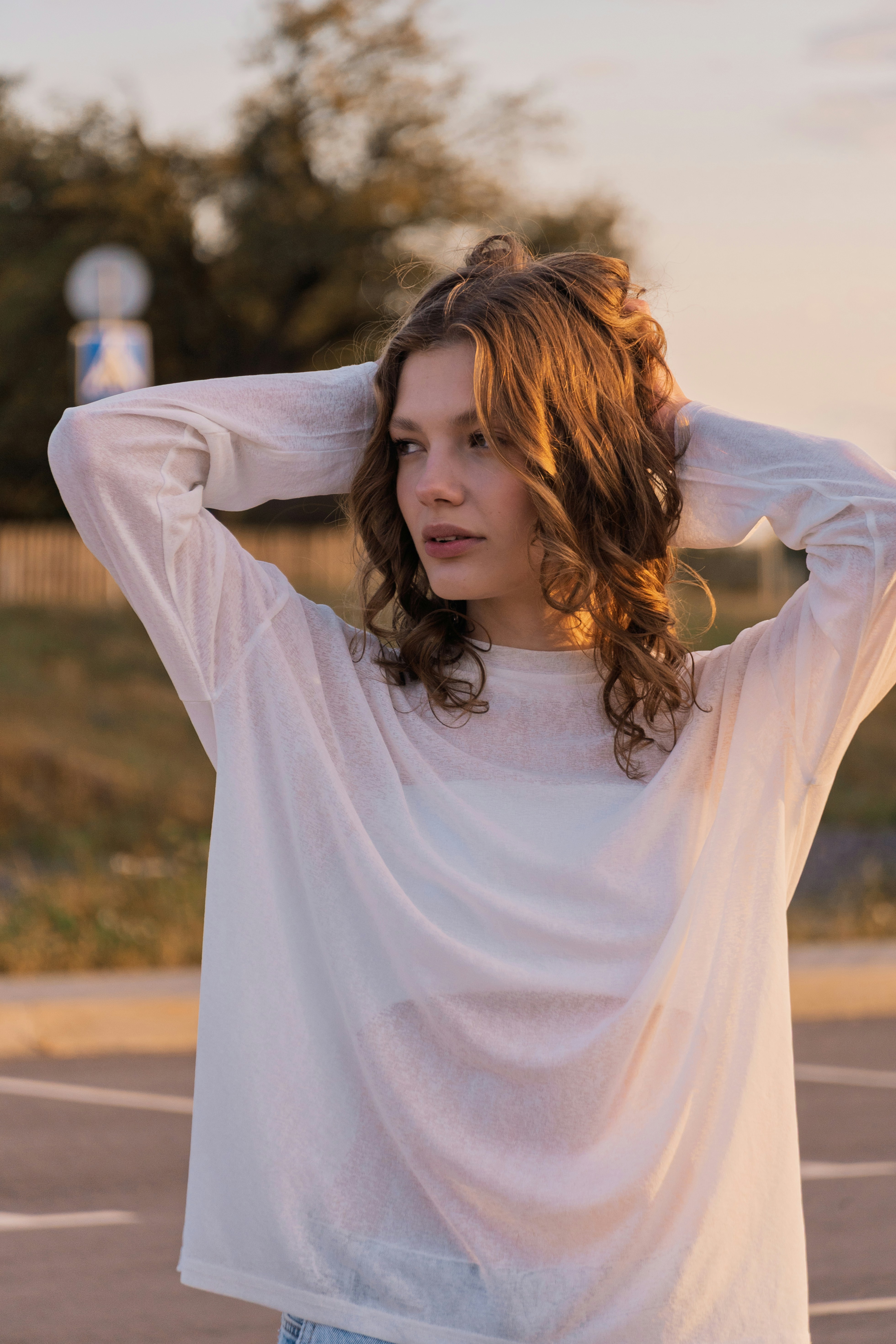 Golden Hour Portrait: Soft Light on a White-Sleeved Ringlet