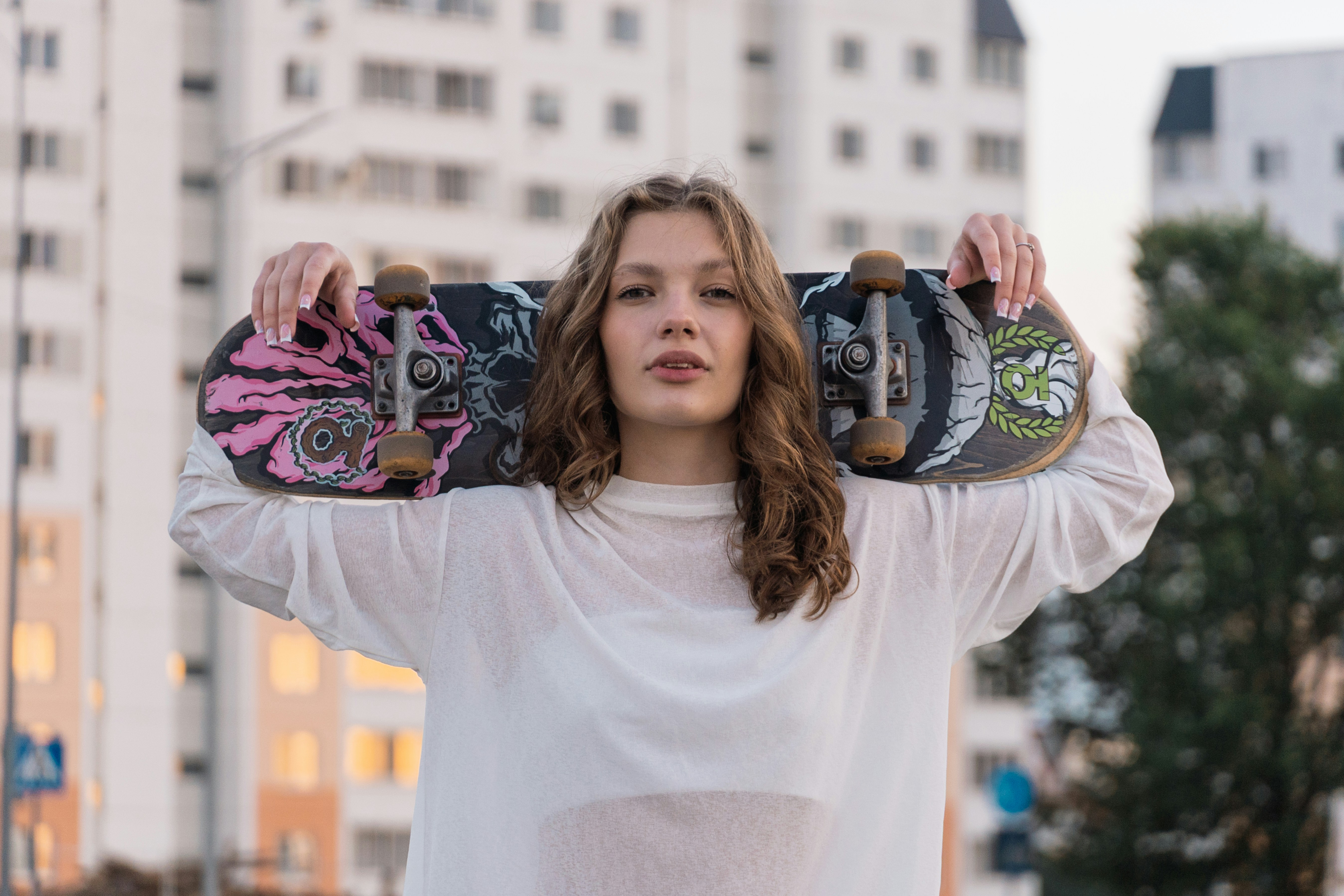 Youthful Balance: A Moment of Skateboard Pride in Urban Light