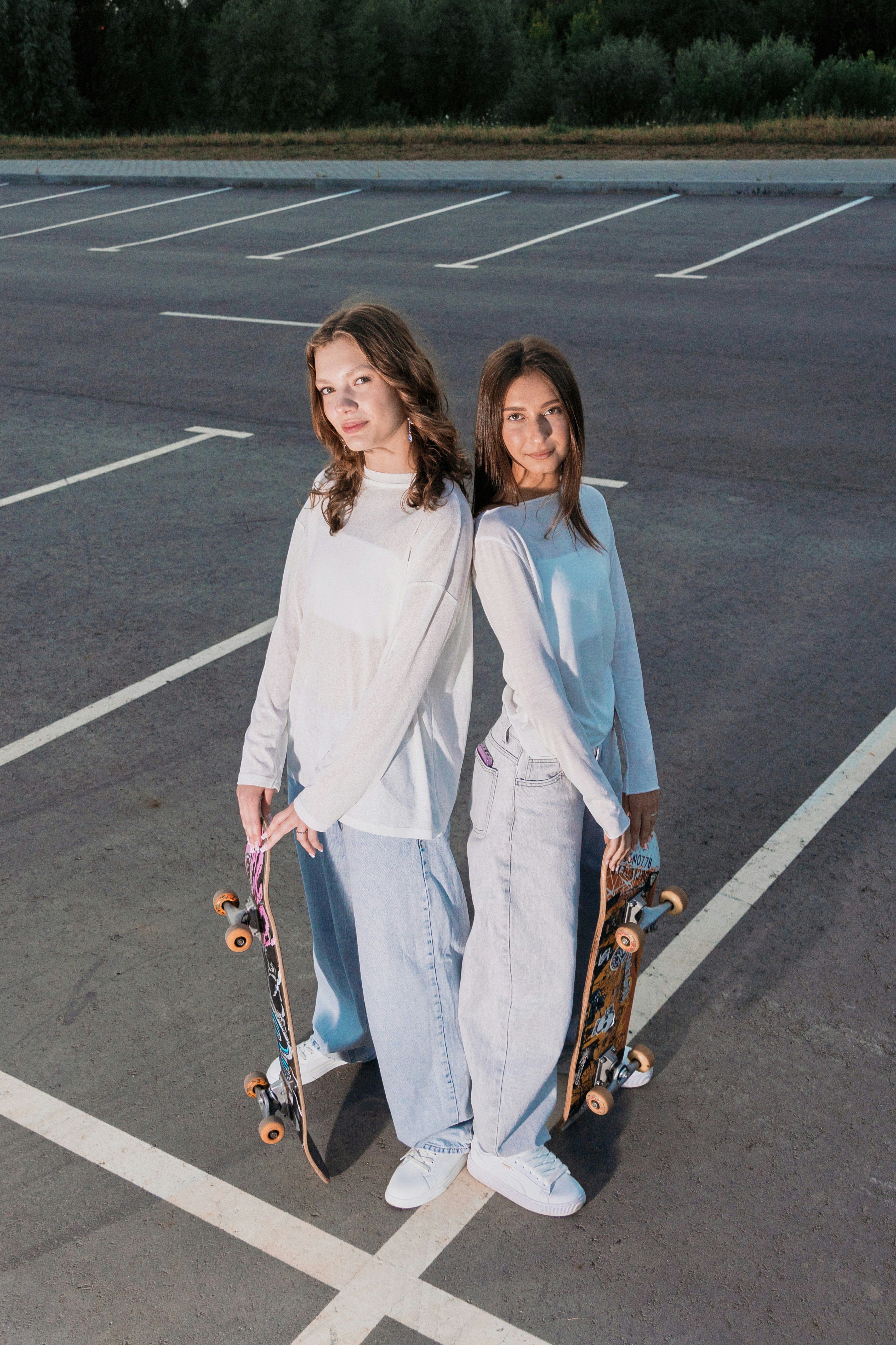 Twin skaters against a striped asphalt horizon