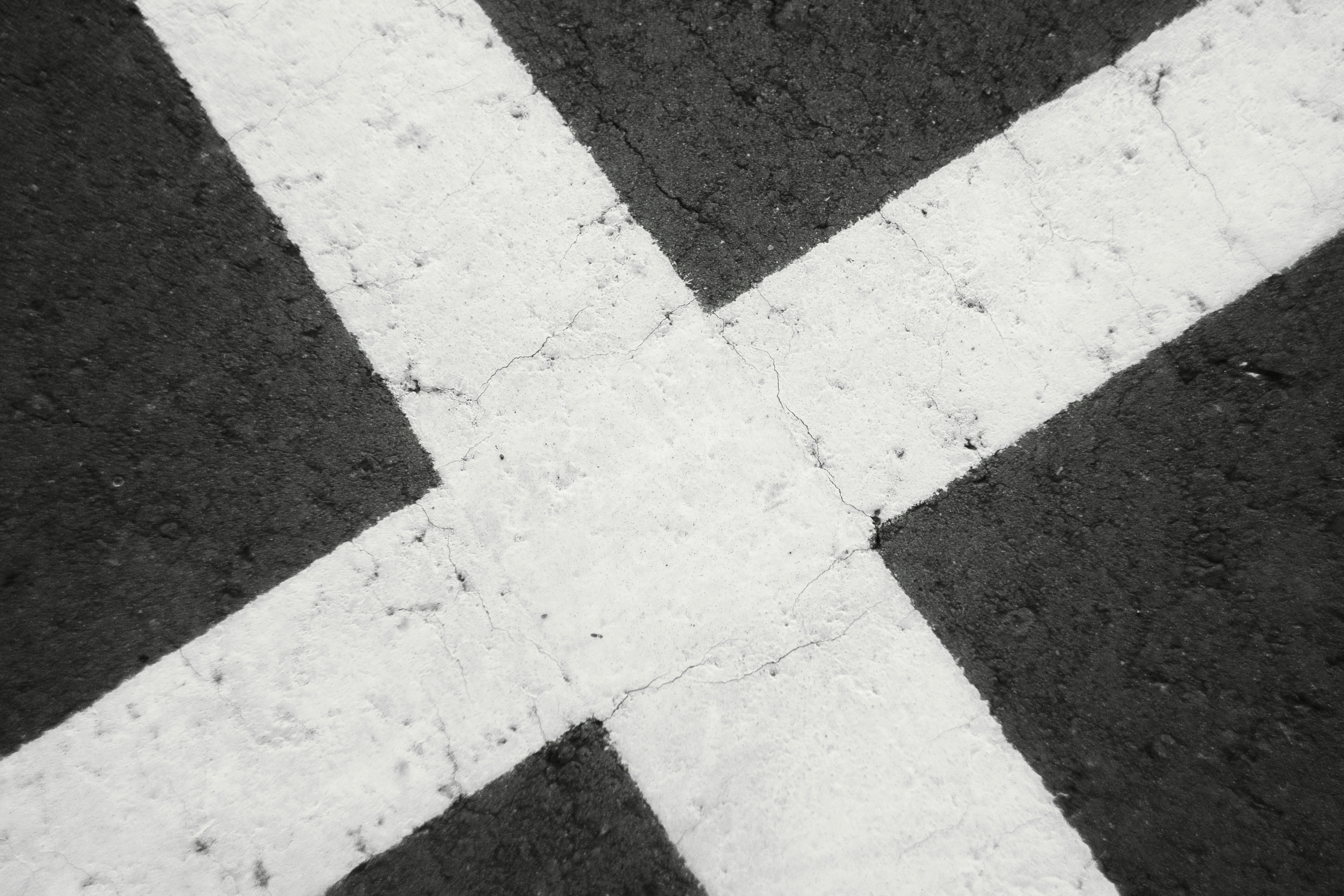 Crosswalk Convergence: Cracked Asphalt meeting White Stripe Lines