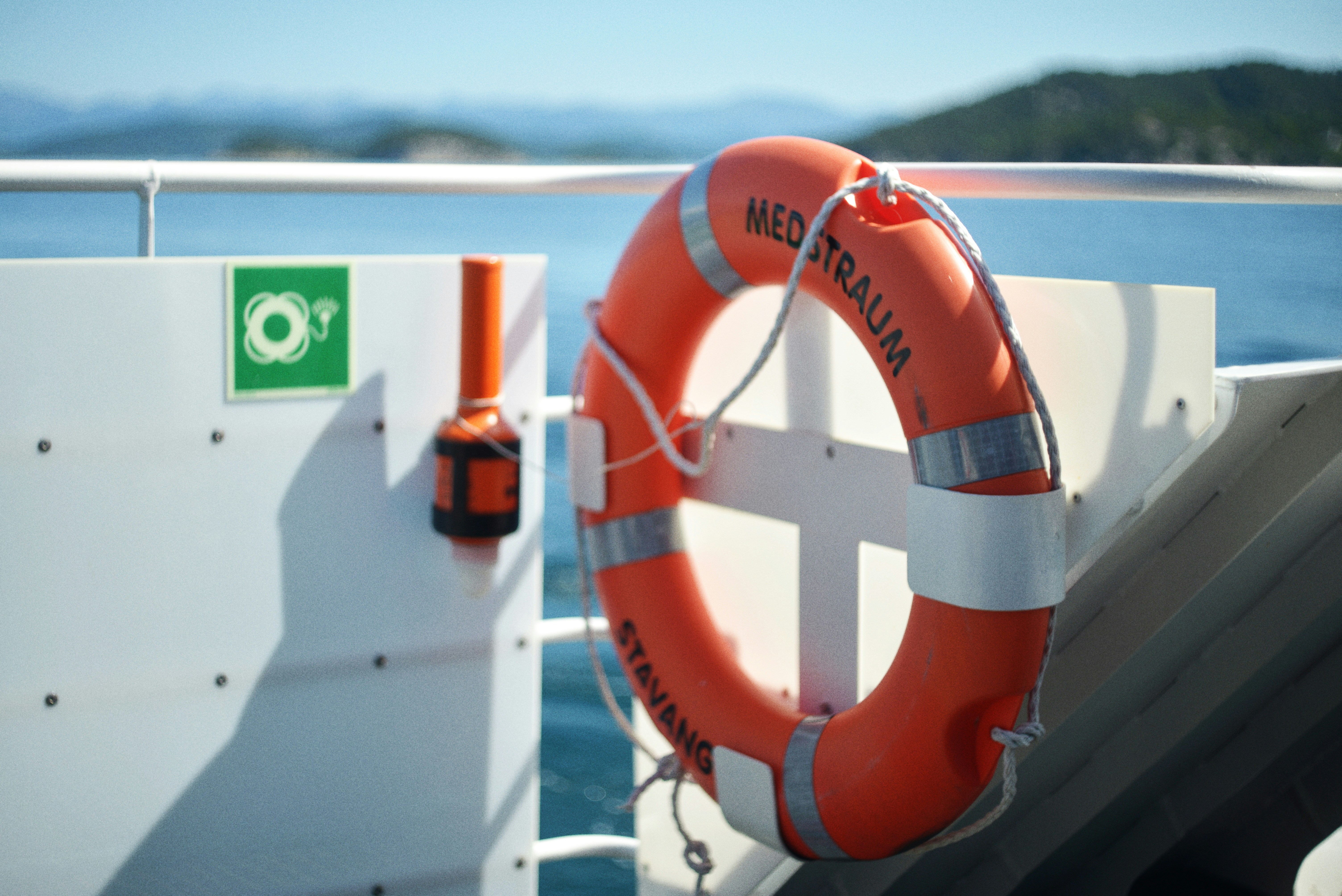 Lifesaver at the Rail: Orange Ring afloat against sea breeze