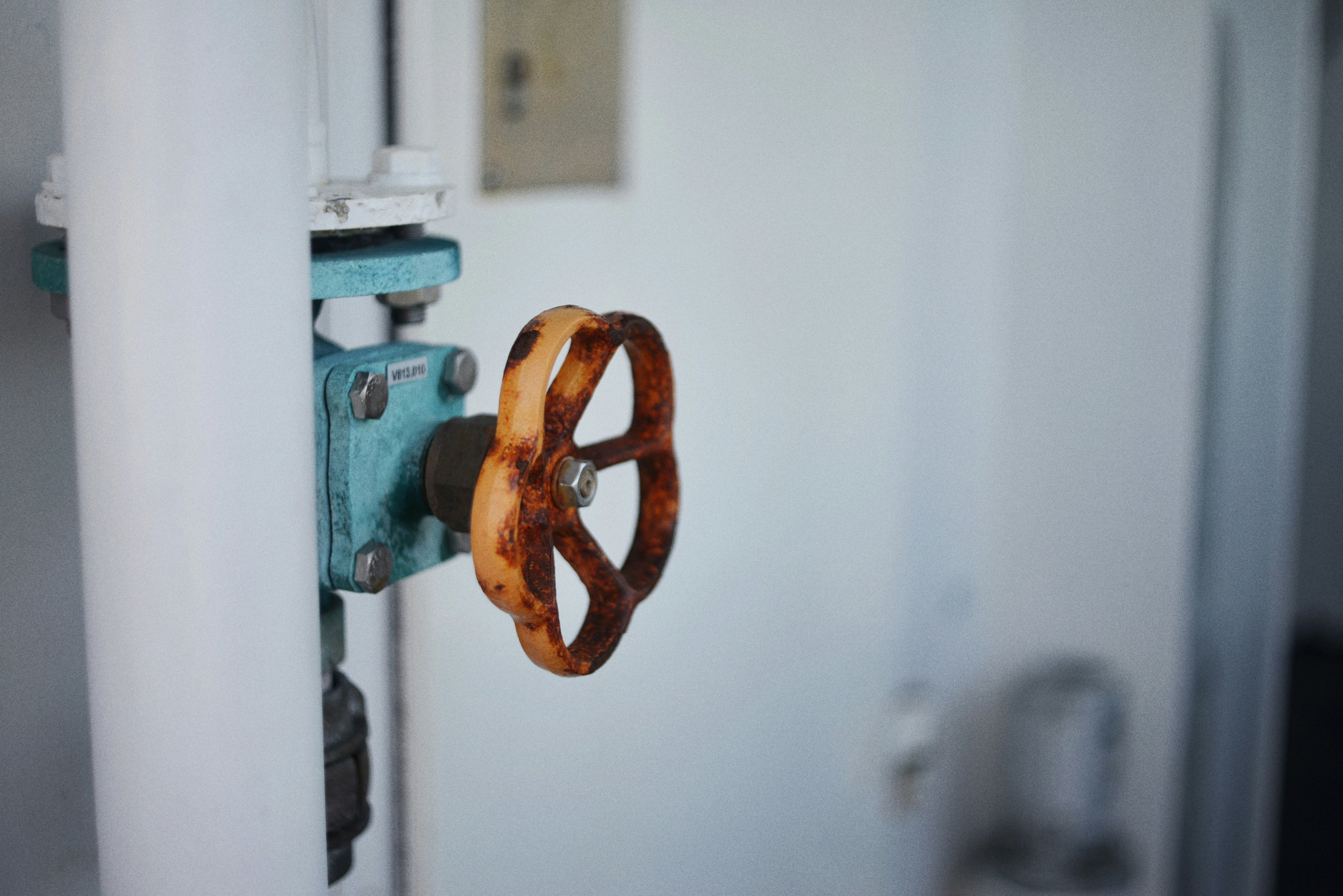 Rusty Wheel Valve on Cold Industrial Pipe