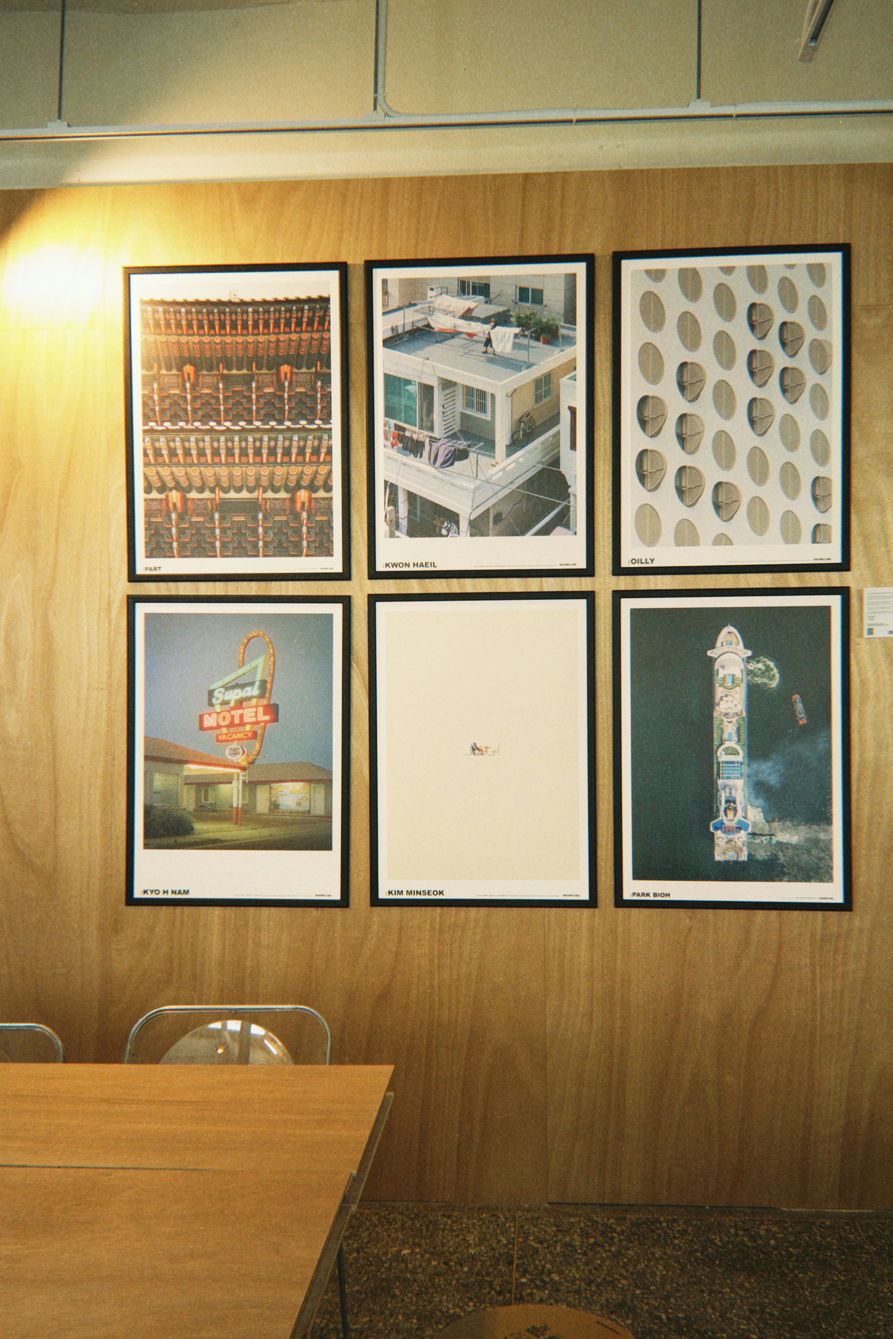 Gallery wall of vintage travel posters in a warmly lit room