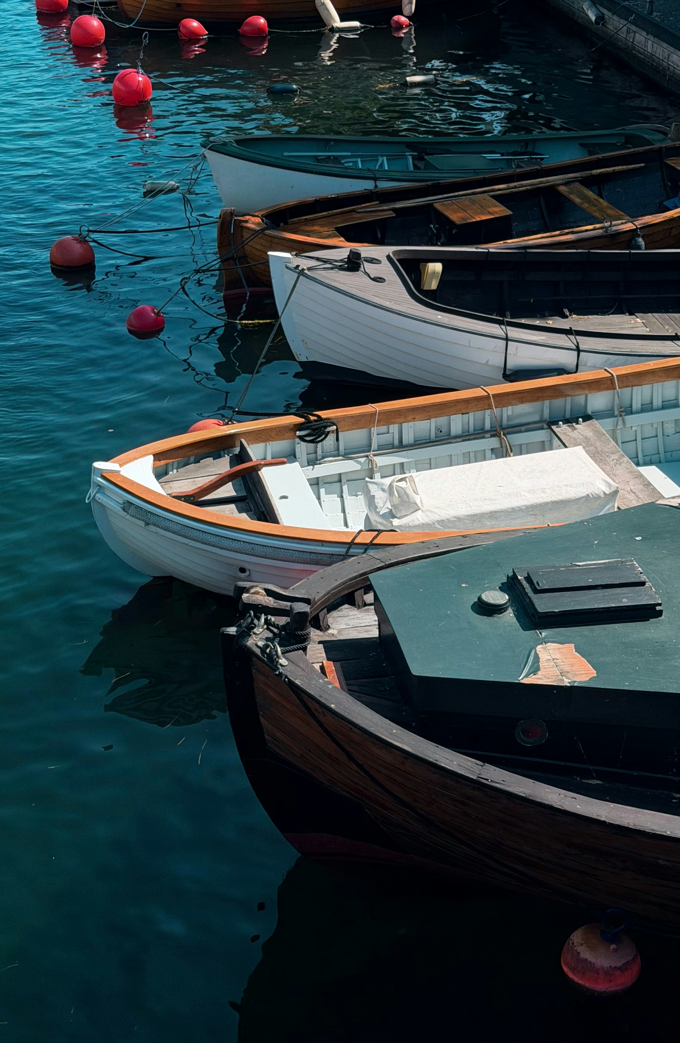 Docked in Quiet Blues: A Fleet of Wooden Boats at Rest
