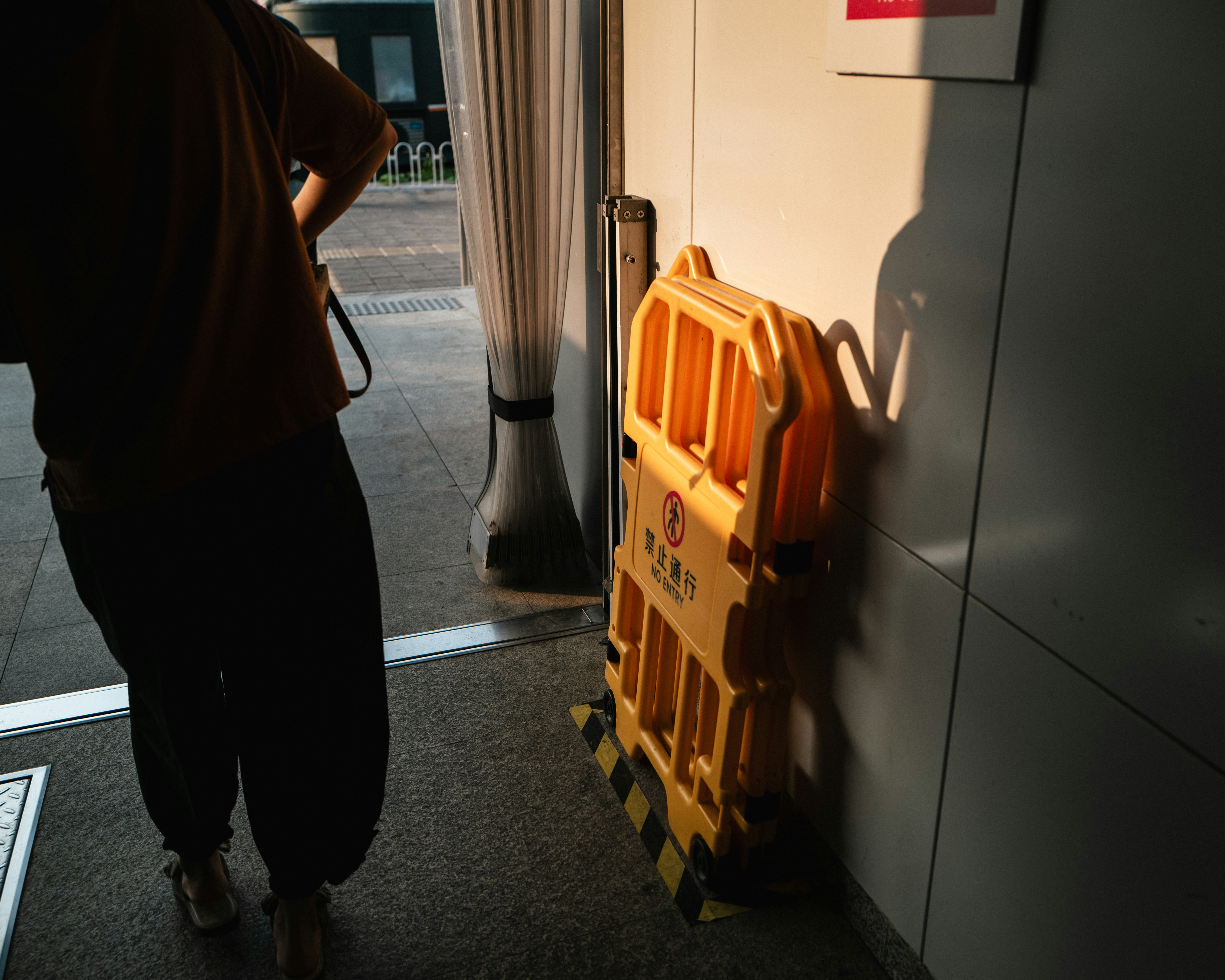 Shadowed Stride toward the Exit: A Quiet Corridor Scene