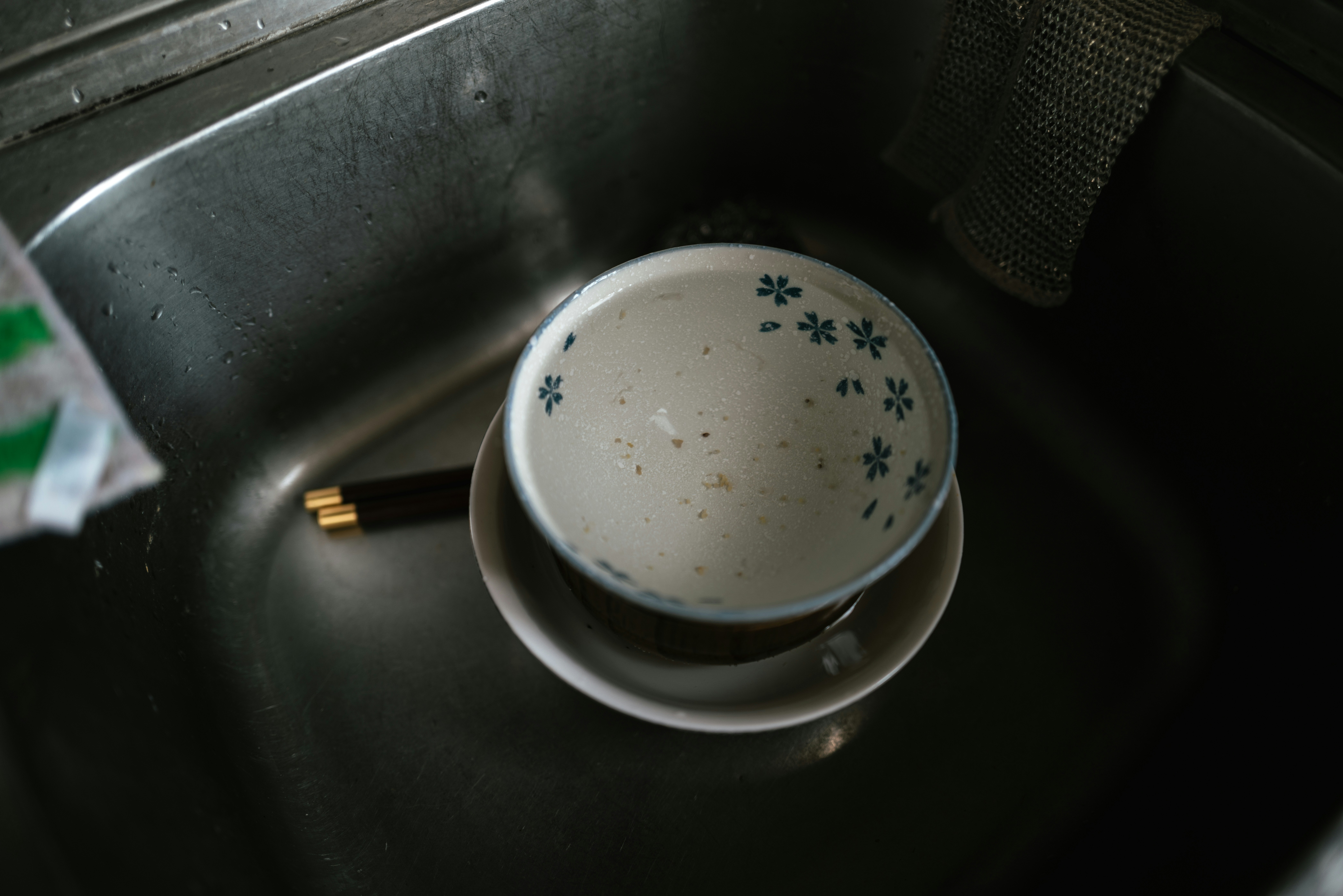 Dingy Sink Morning: A Delicate Cup Soaked in Silence