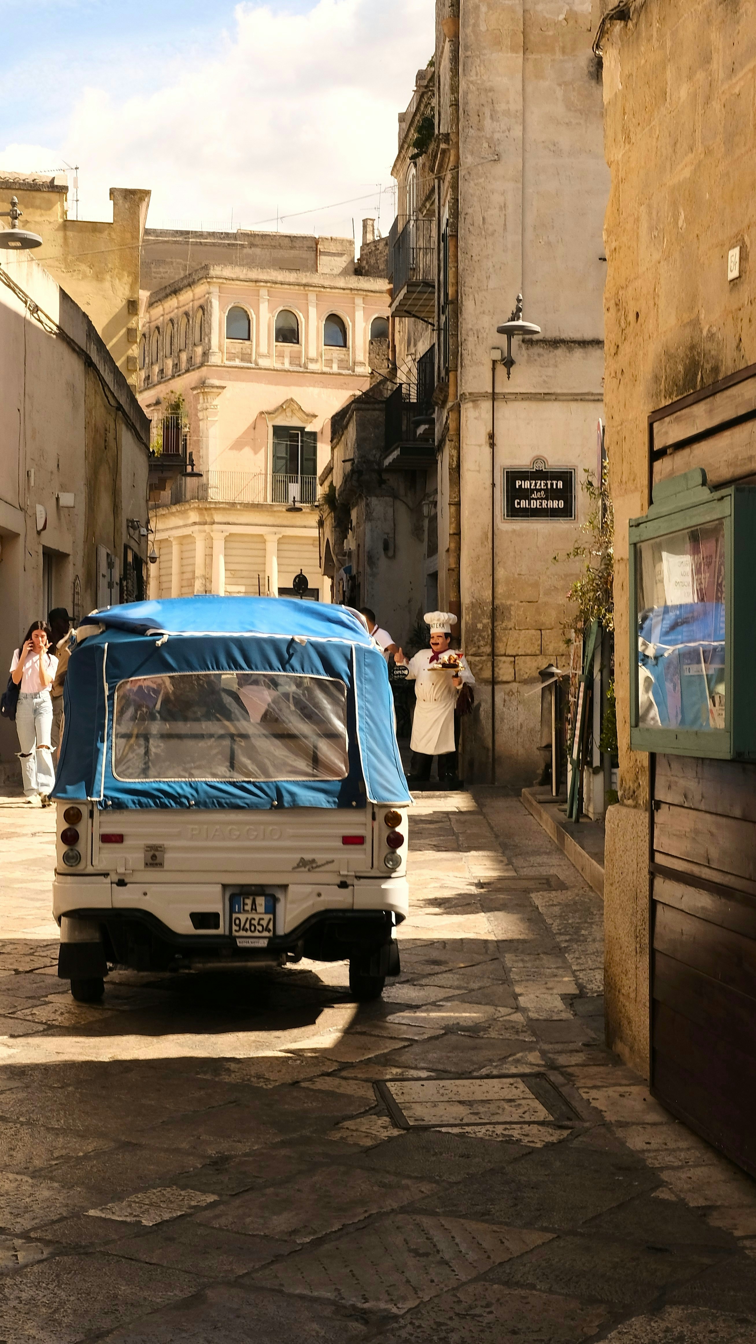 Blue-Topped Jeep in Narrow Mediterranean Alleys
