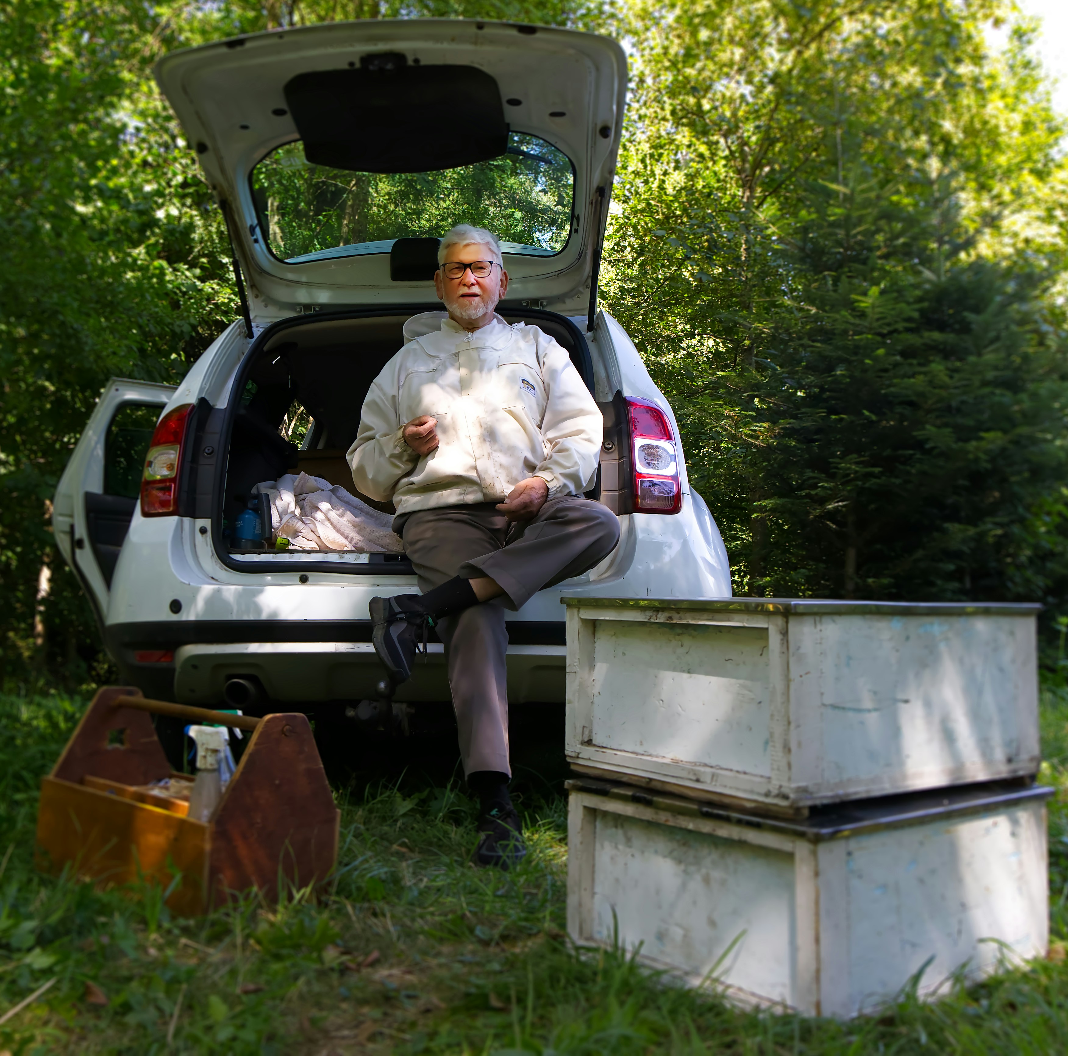 Sitting on the Threshold: An Elder in the Trunk of a Car Amid Orchard Light