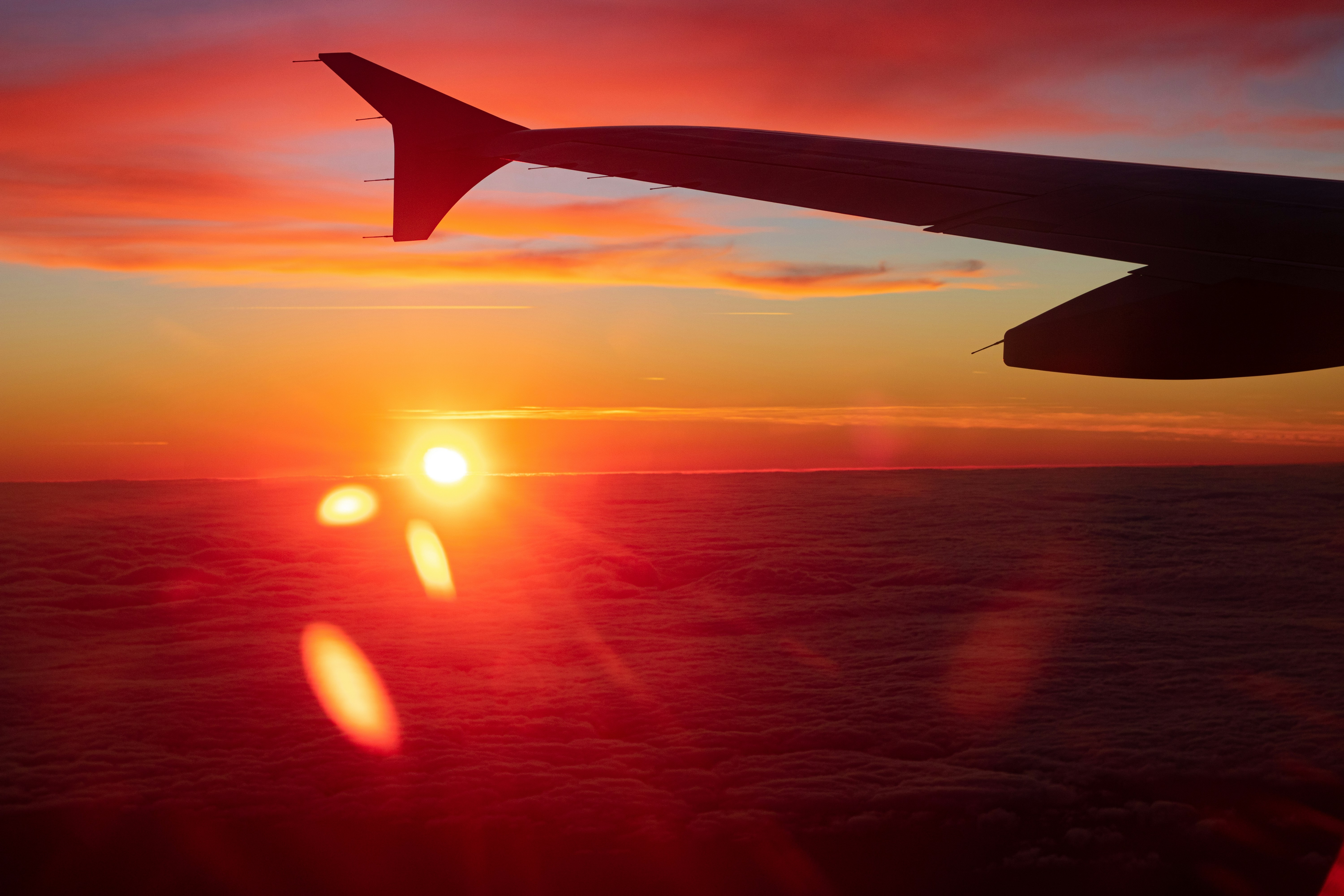 Sunlit Wing: A Window to Glowing Skies During Descent