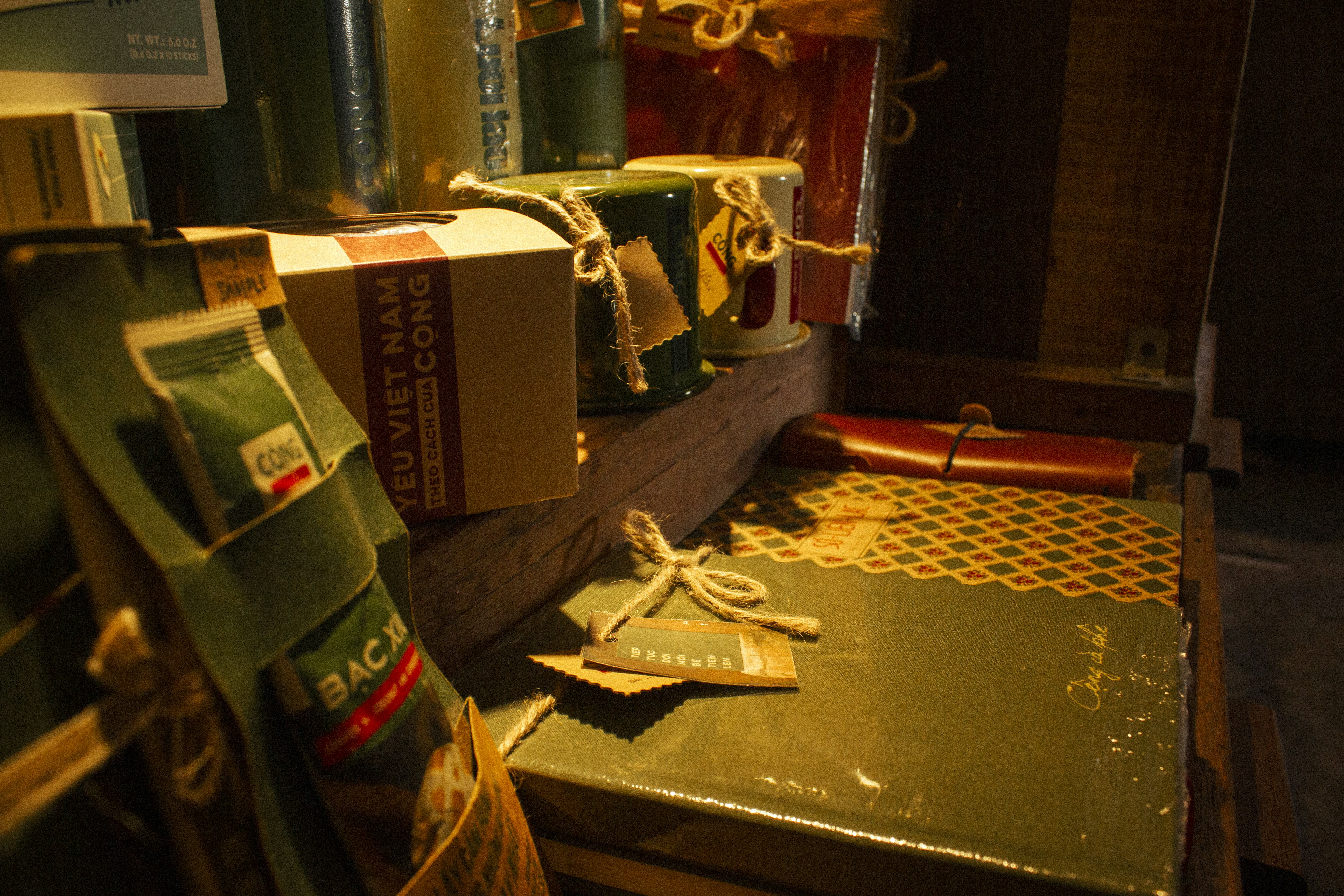 Shelf of Vintage Boxes and Tags in Dim Warm Light