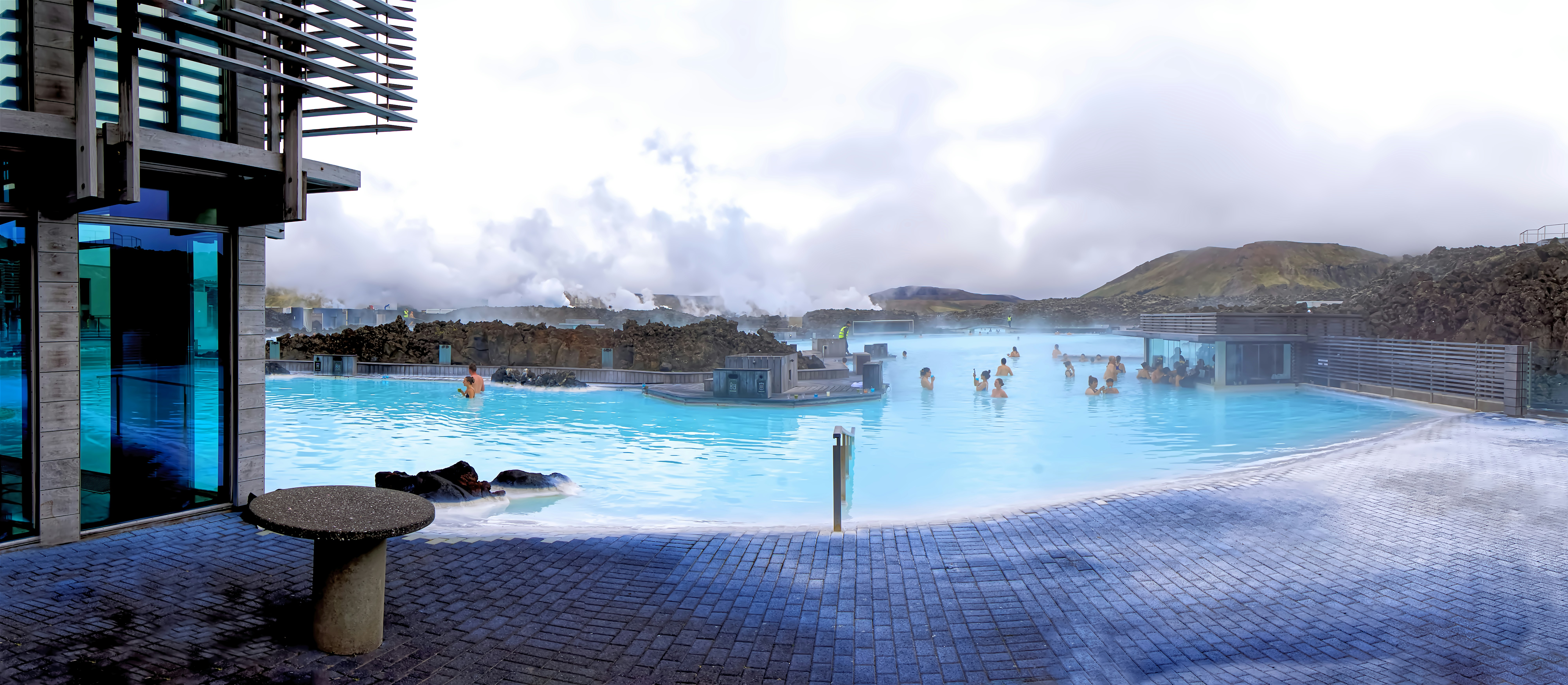 Cascading Mist and Turquoise Delta: A Thermal Oasis Pool at Dusk